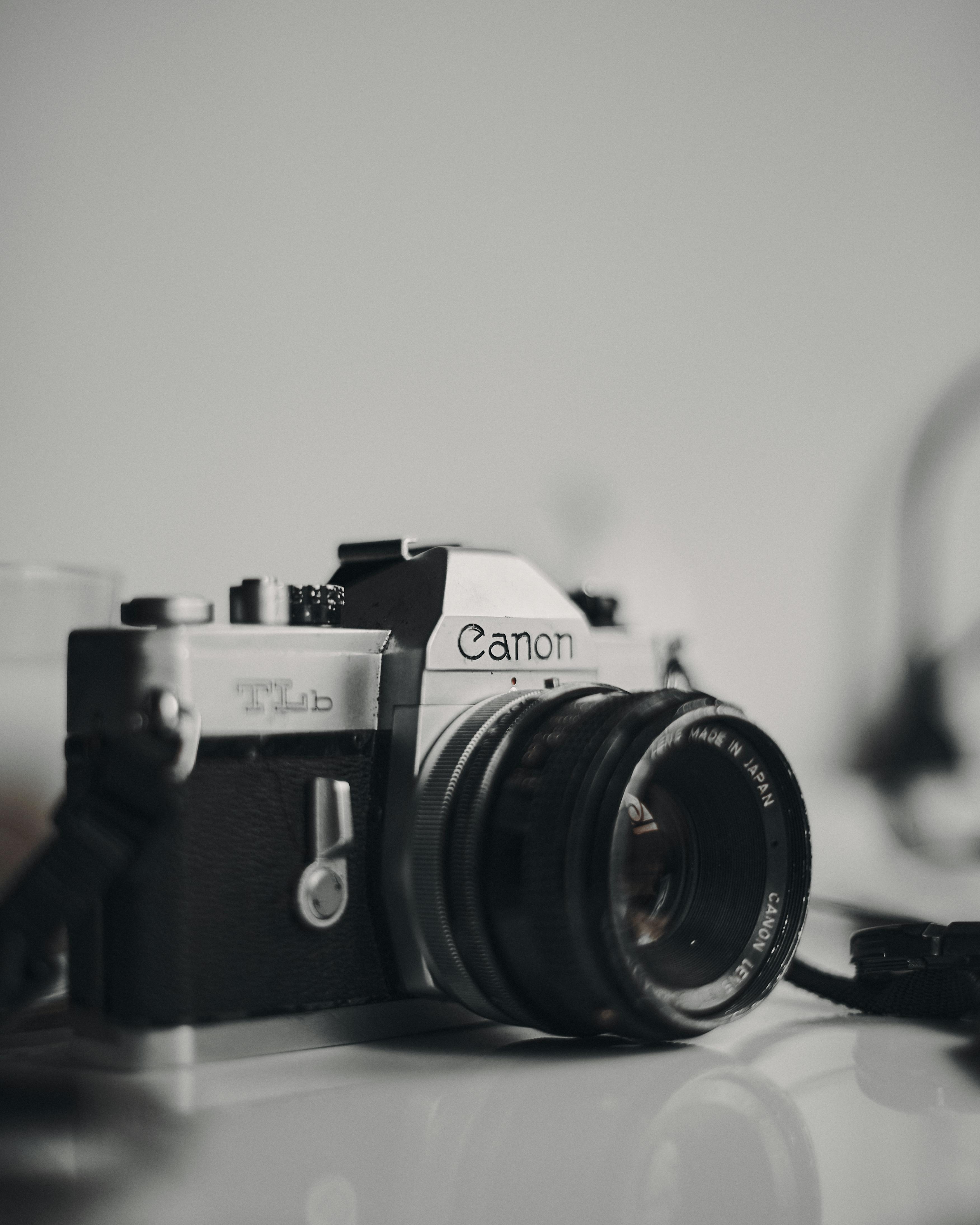 Close-Up Photo of a Camera Canon with a Green Strap · Free Stock Photo