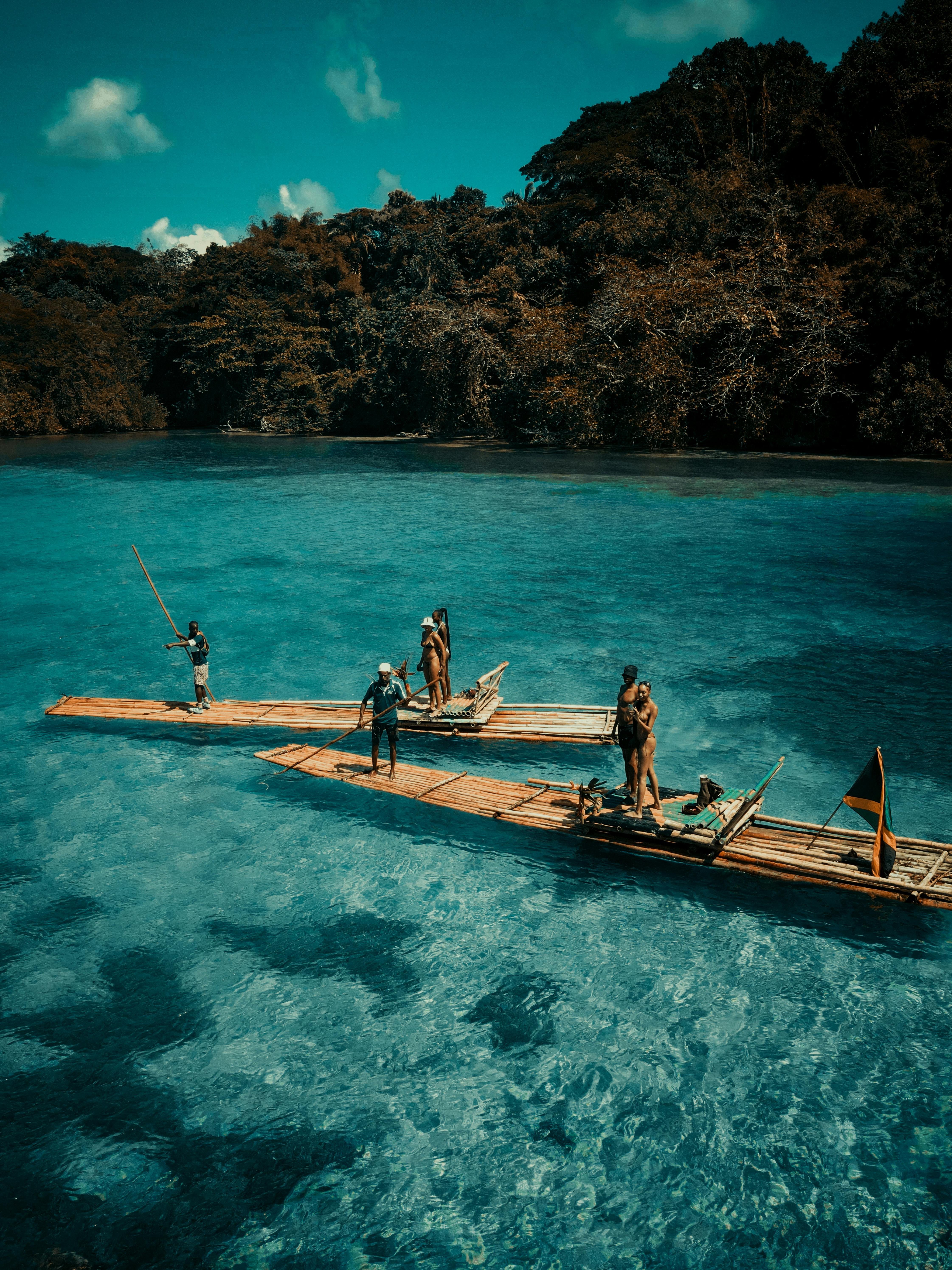 People on a Wooden Raft in Clear Blue Water · Free Stock Photo