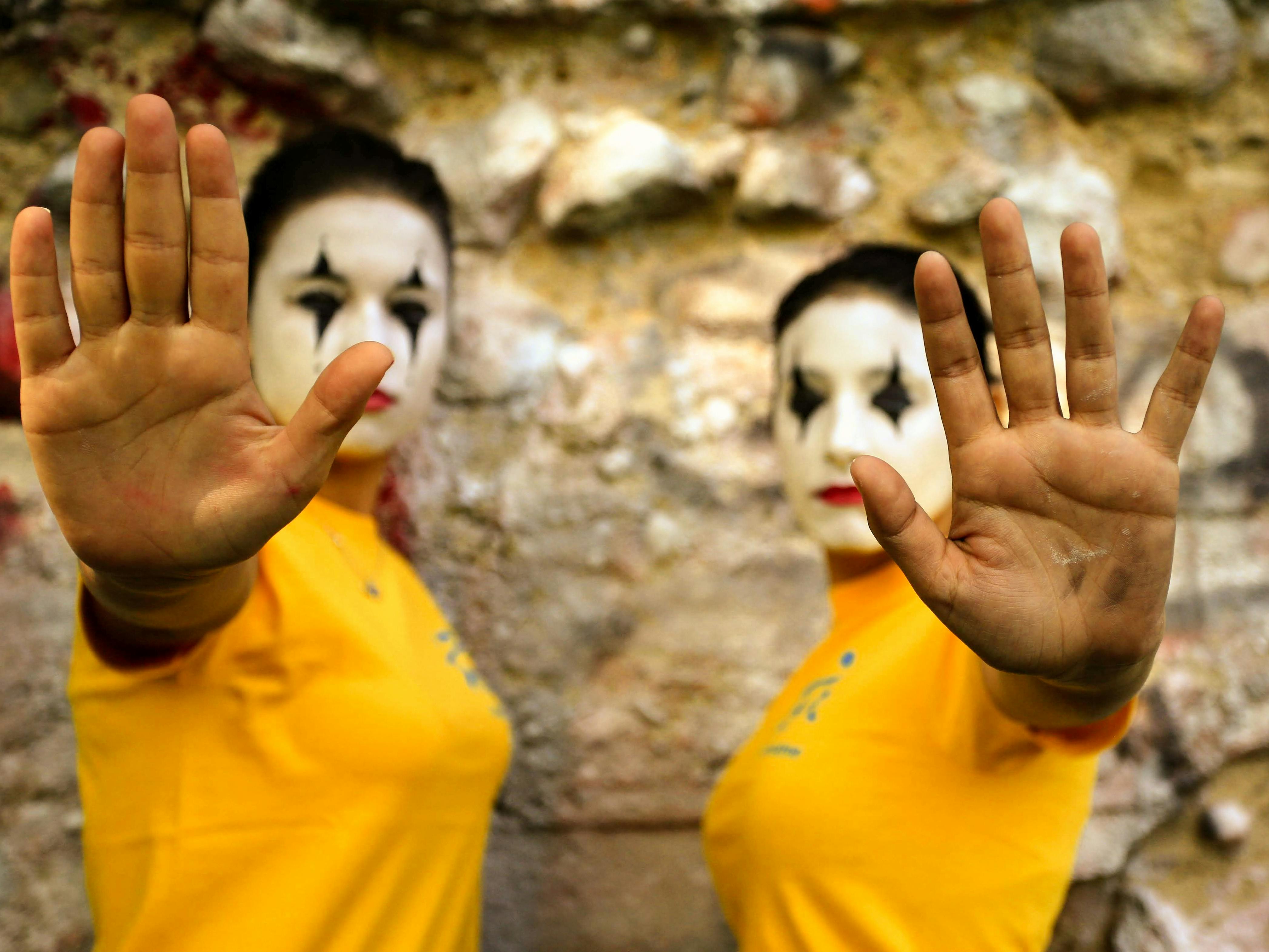 Photo of Two Women with Painted Faces Raising Their Hands in an Act of ...