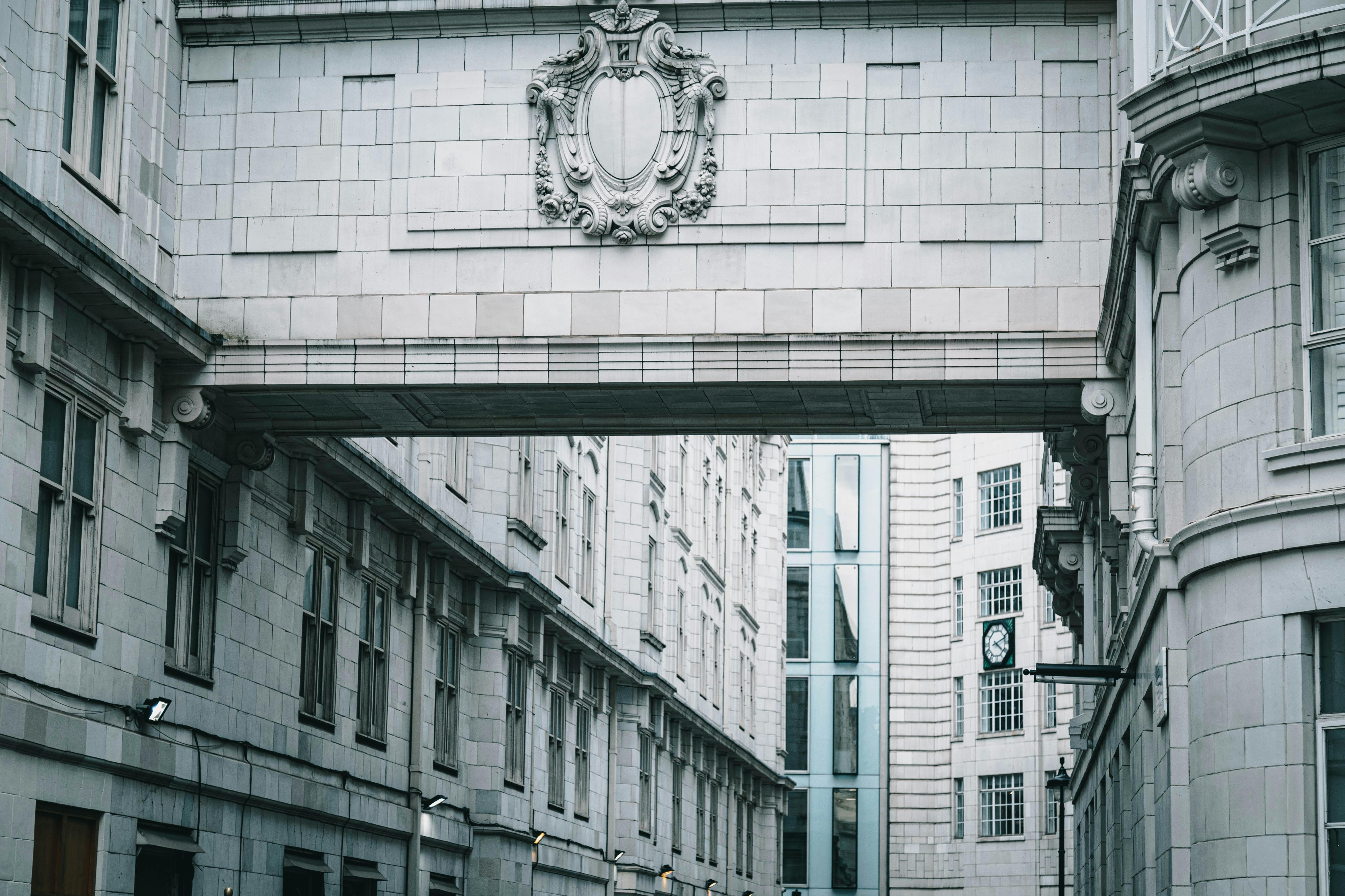 Old Concrete Bridge between Old Buildings · Free Stock Photo