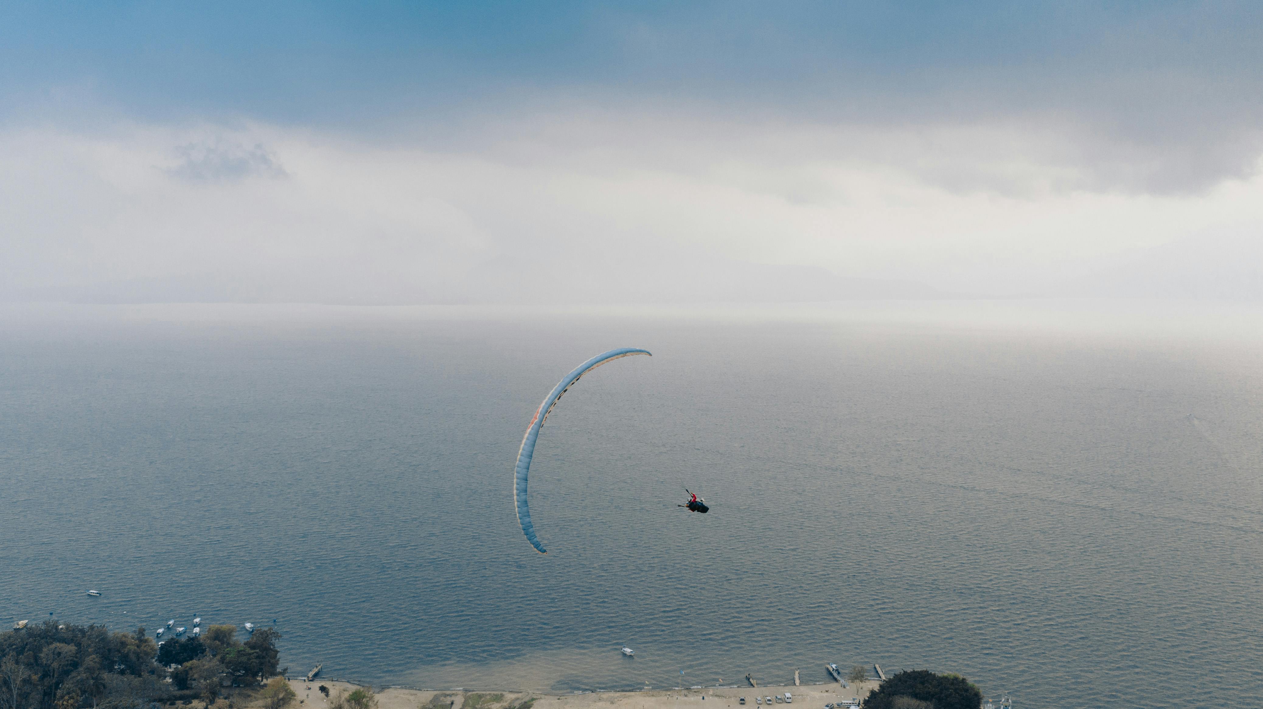 Panorama Photo of a Person Parachuting Above Volcano Lake during ...
