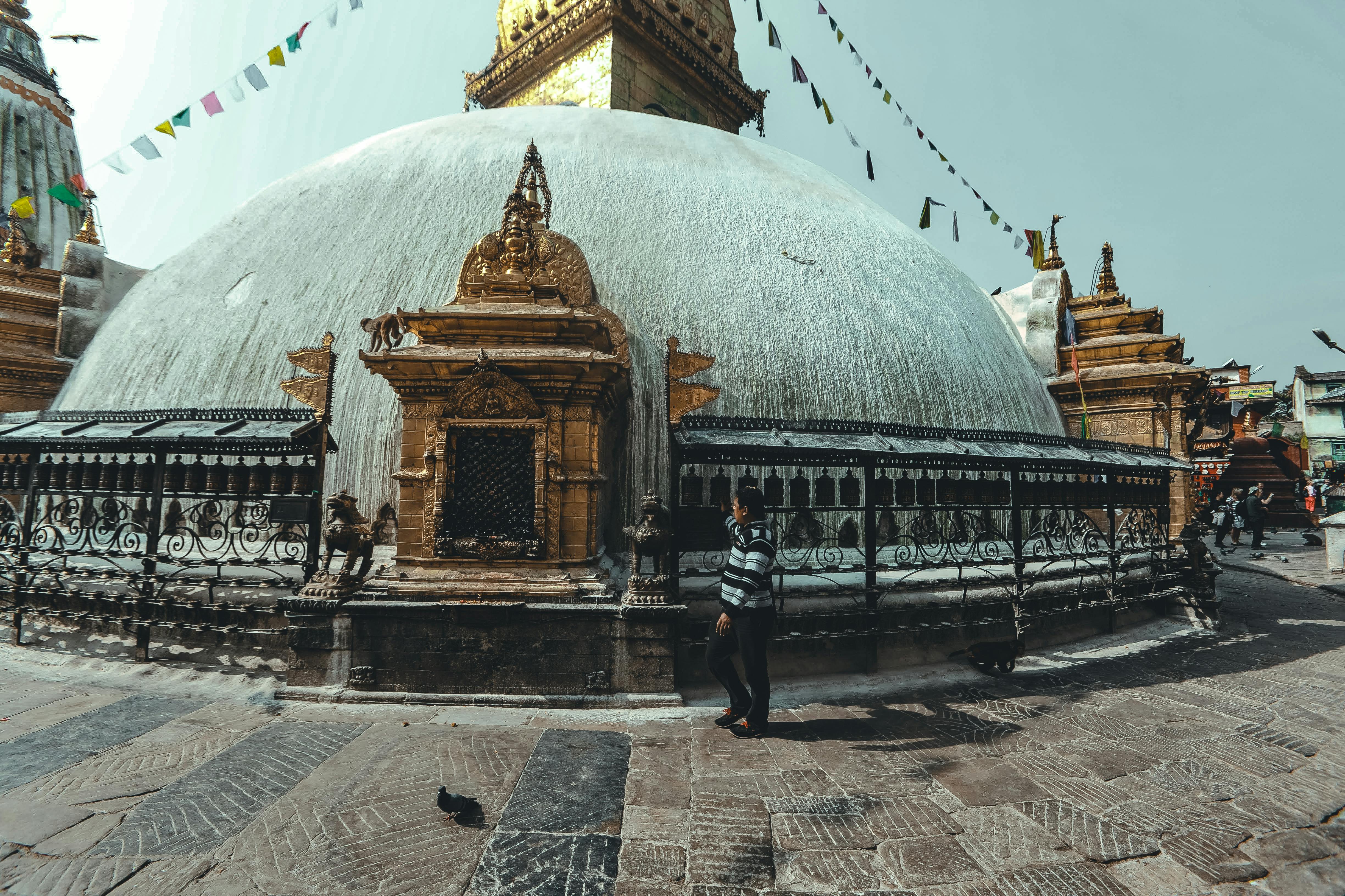 A Man Standing in Front of Swayambhu · Free Stock Photo
