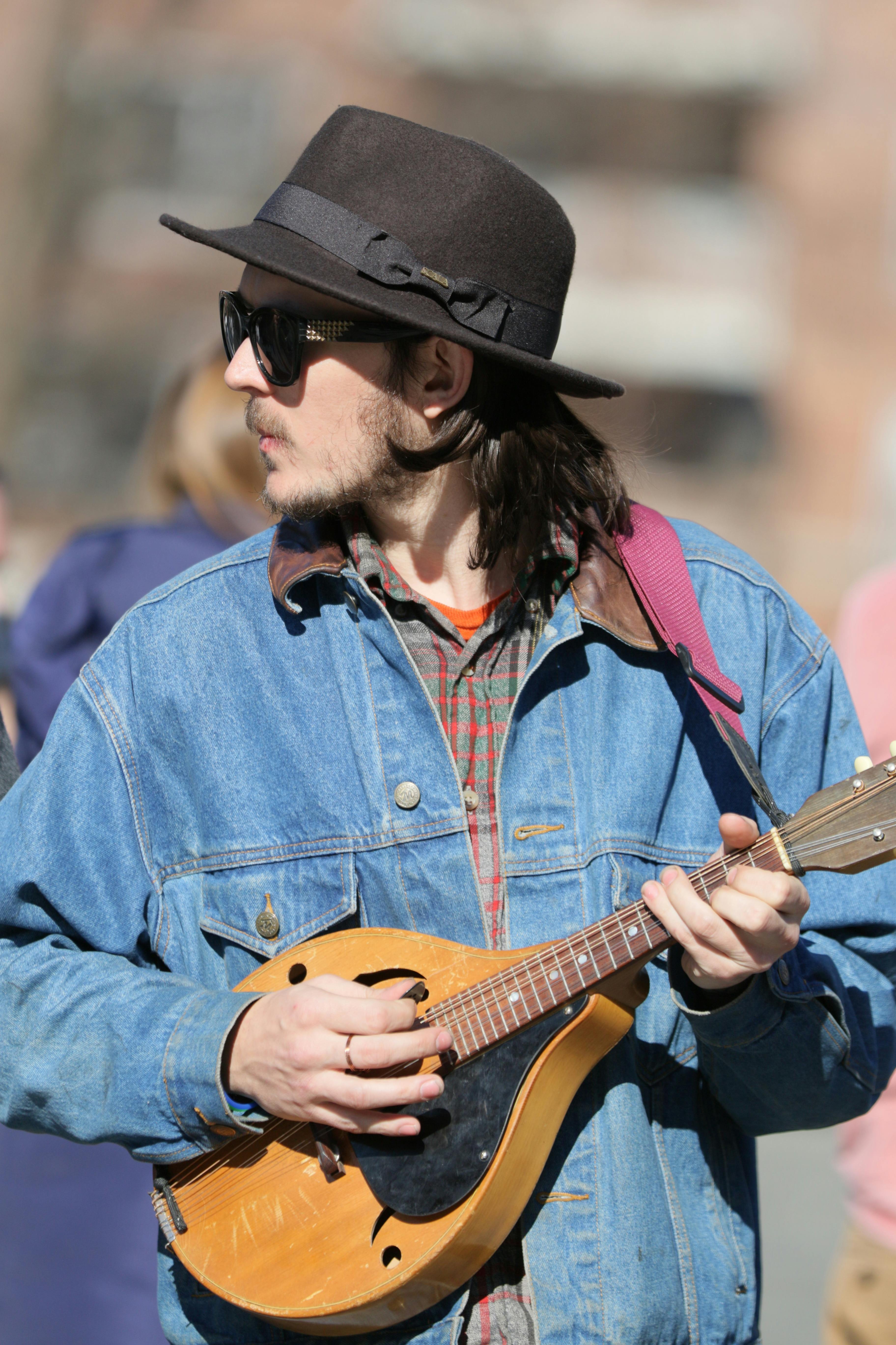 A Man in Blue Denim Button-Up Jacket Playing Mandolin · Free Stock Photo
