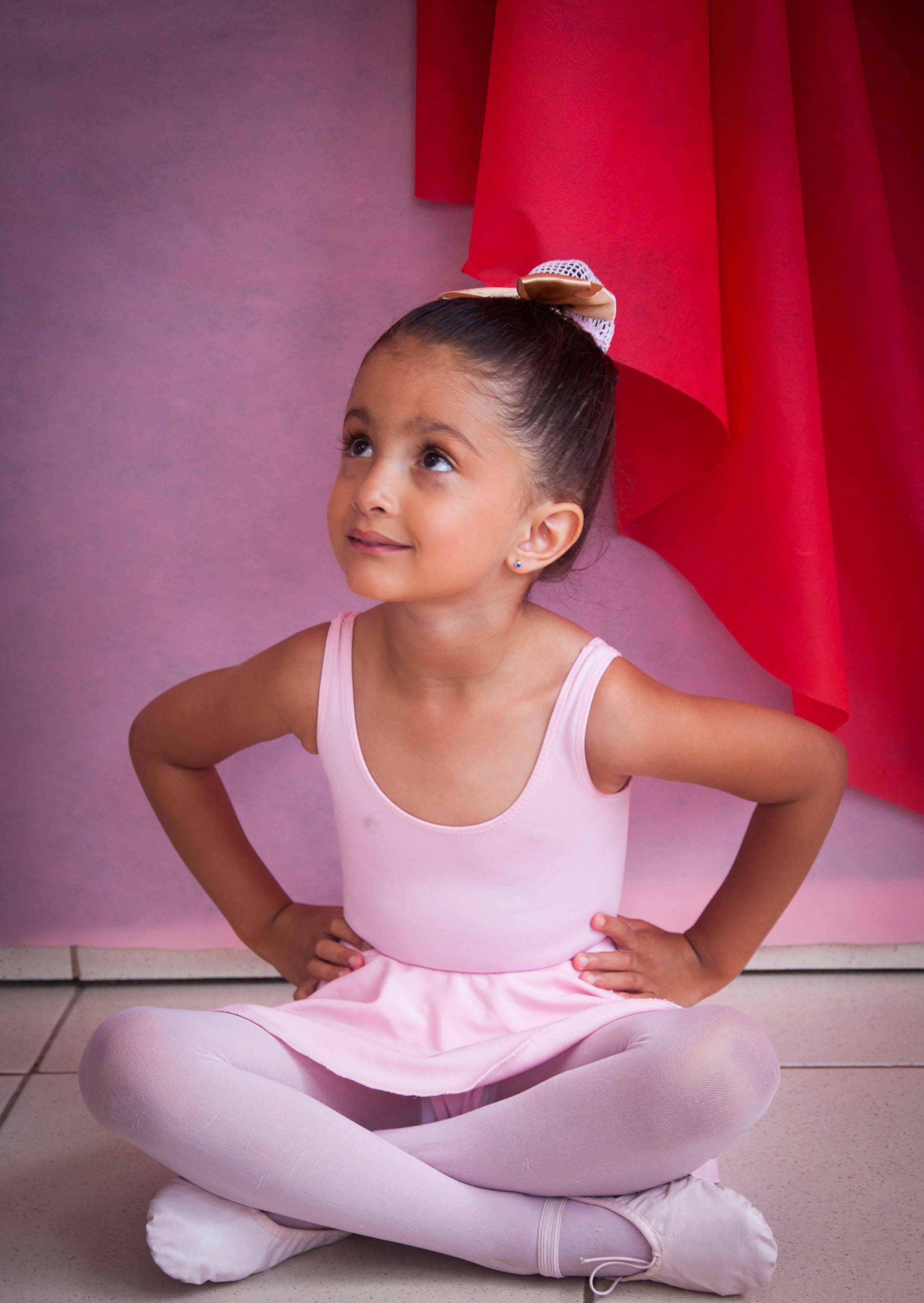 Girl in Pink Ballet Costume Sitting on Floor with Hands on Hips · Free ...