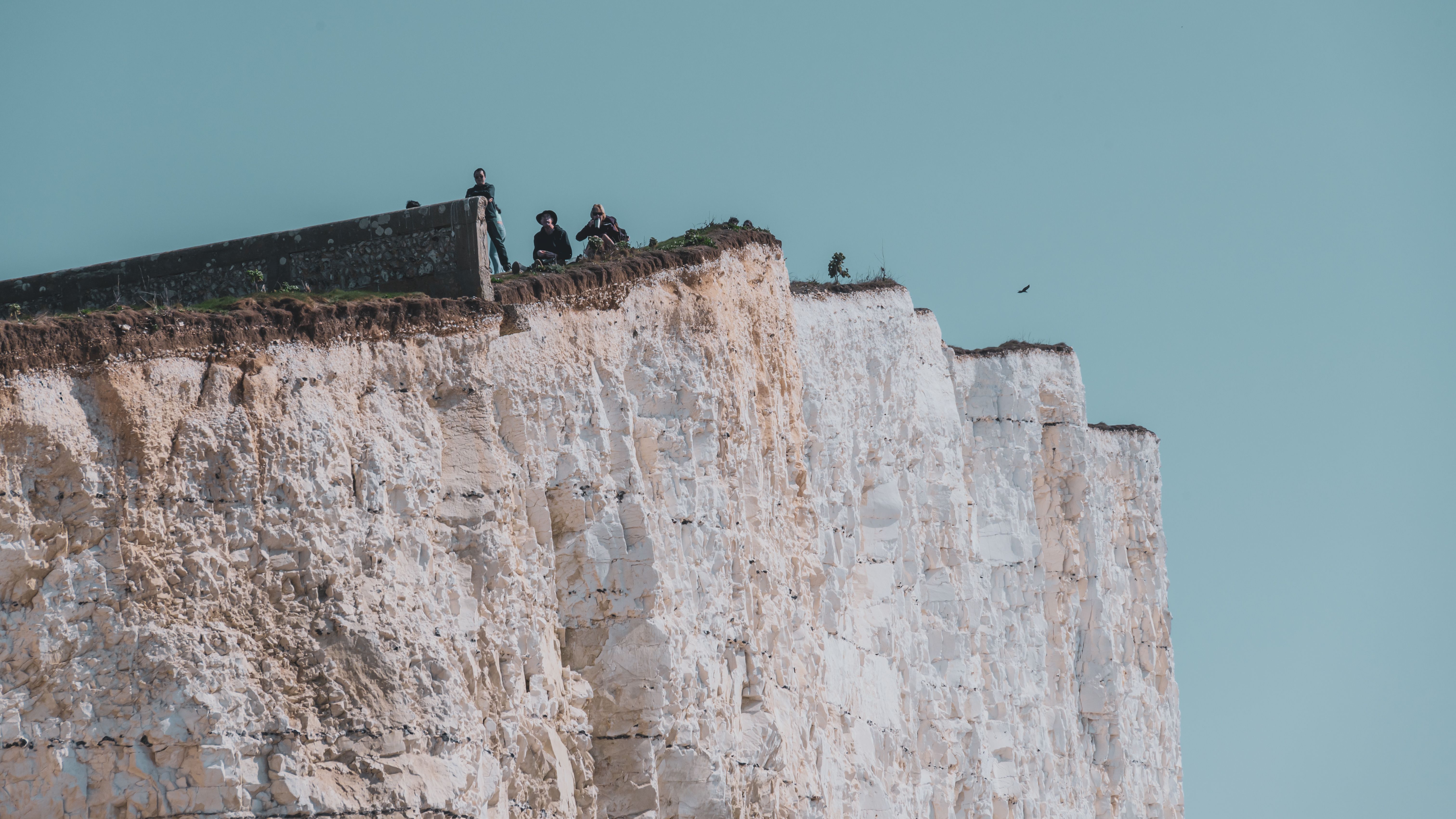 People on Top of a Sea Cliff Under a Clear Blue Sky · Free Stock Photo