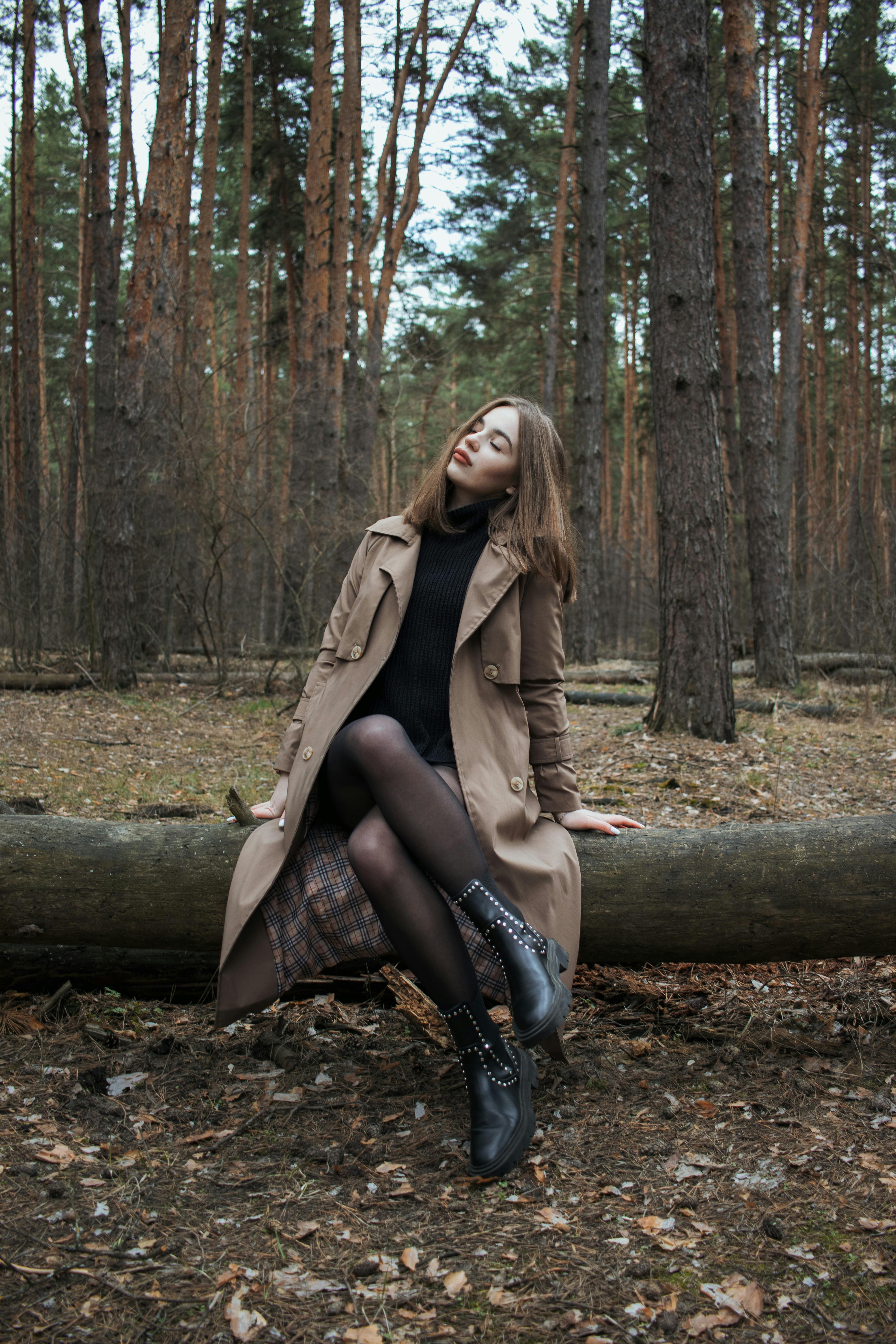A Woman Sitting on a Tree Log · Free Stock Photo