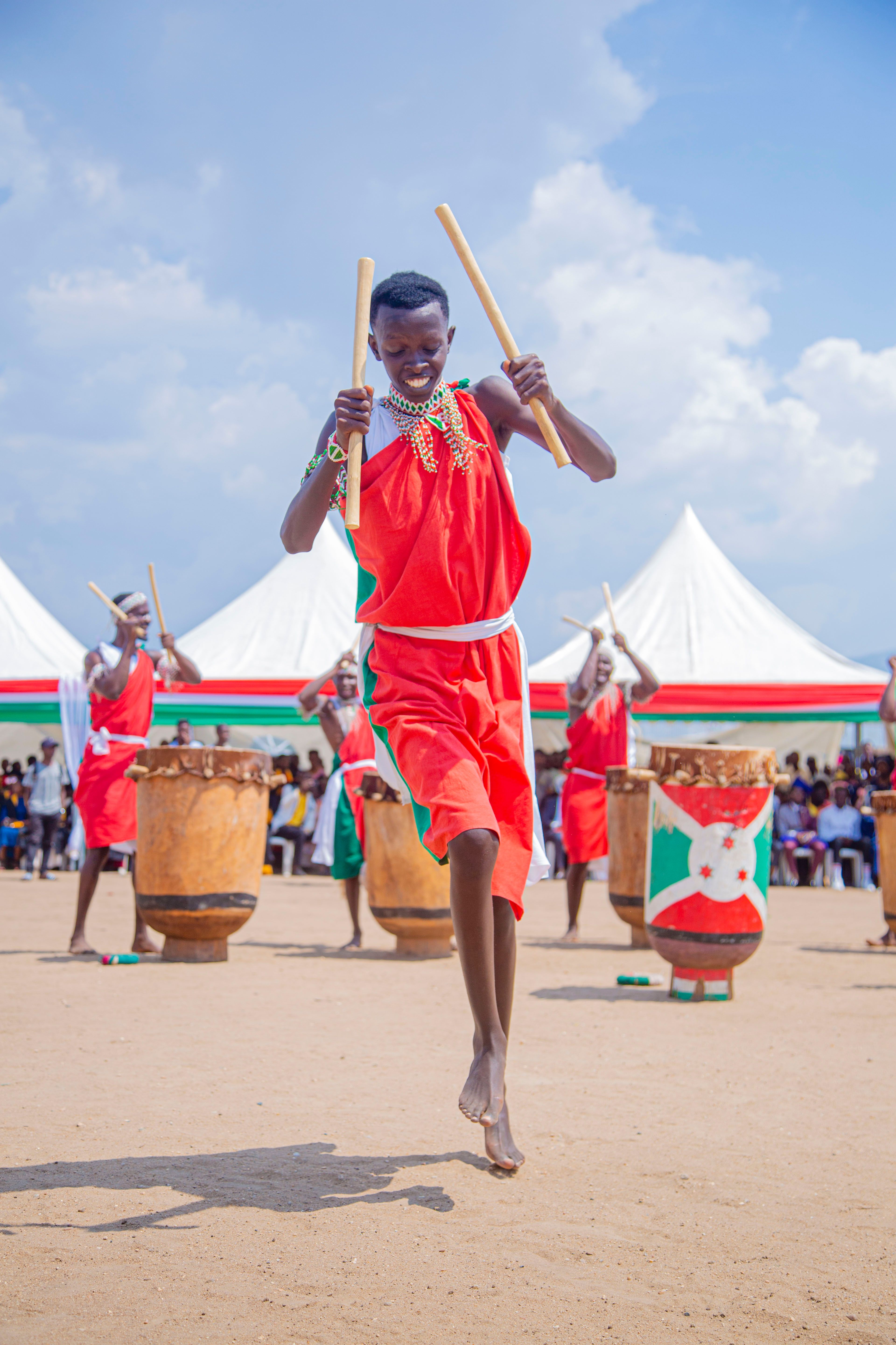 Man in Red and White Traditional Dress Holding Brown Wooden Stick ...