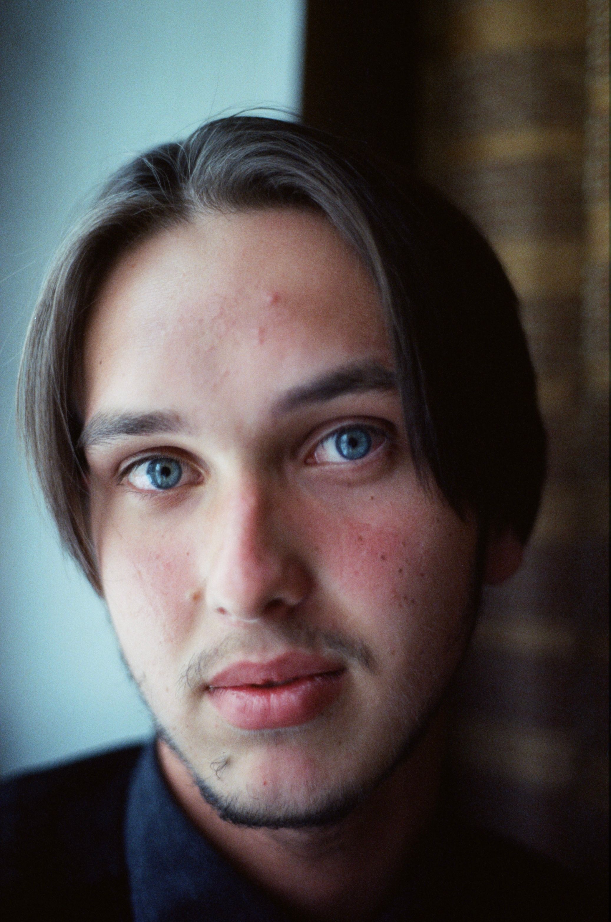 A Close-up Shot of a Man's Face with Flowers · Free Stock Photo
