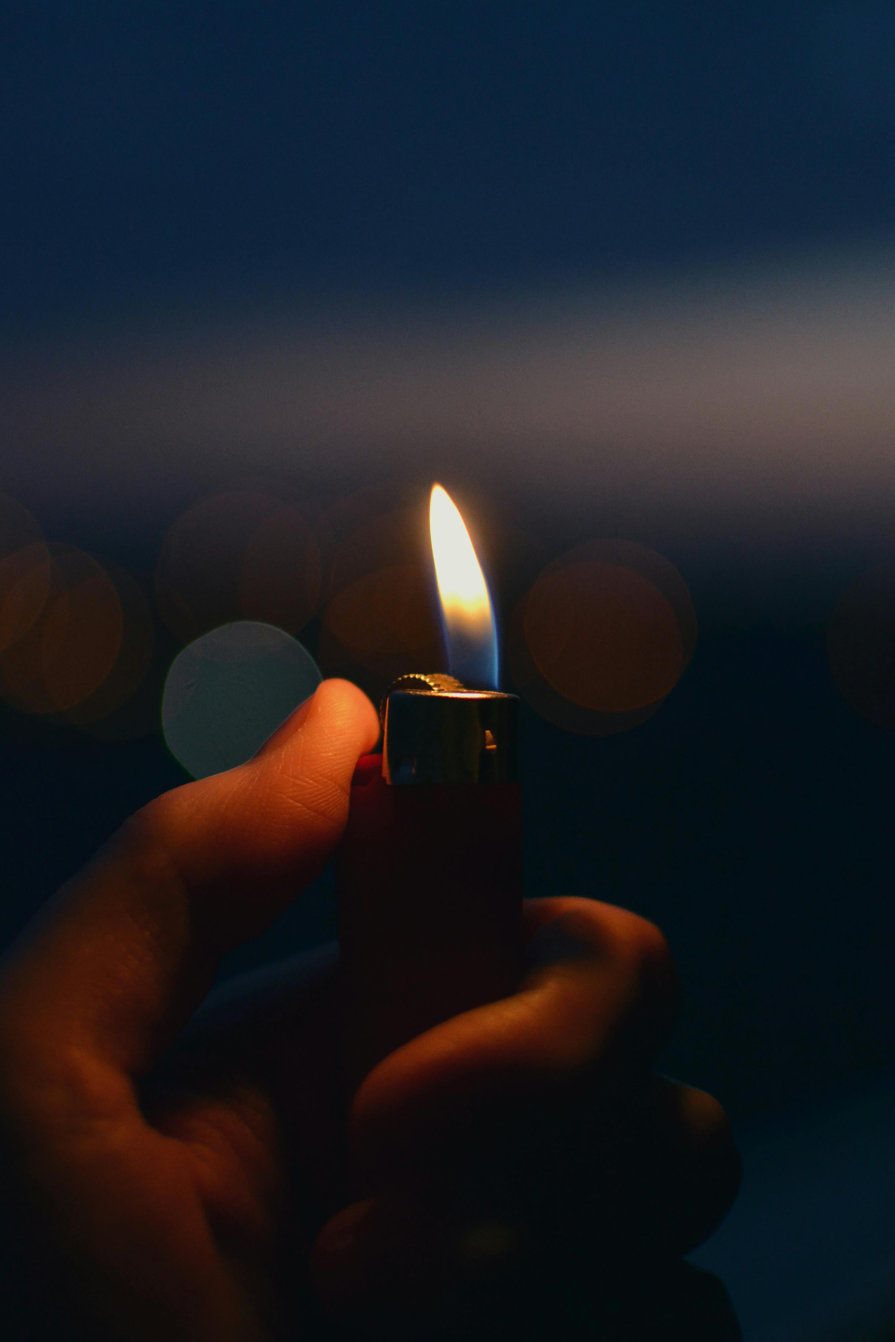 Person Holding Lighted Disposable Lighter · Free Stock Photo