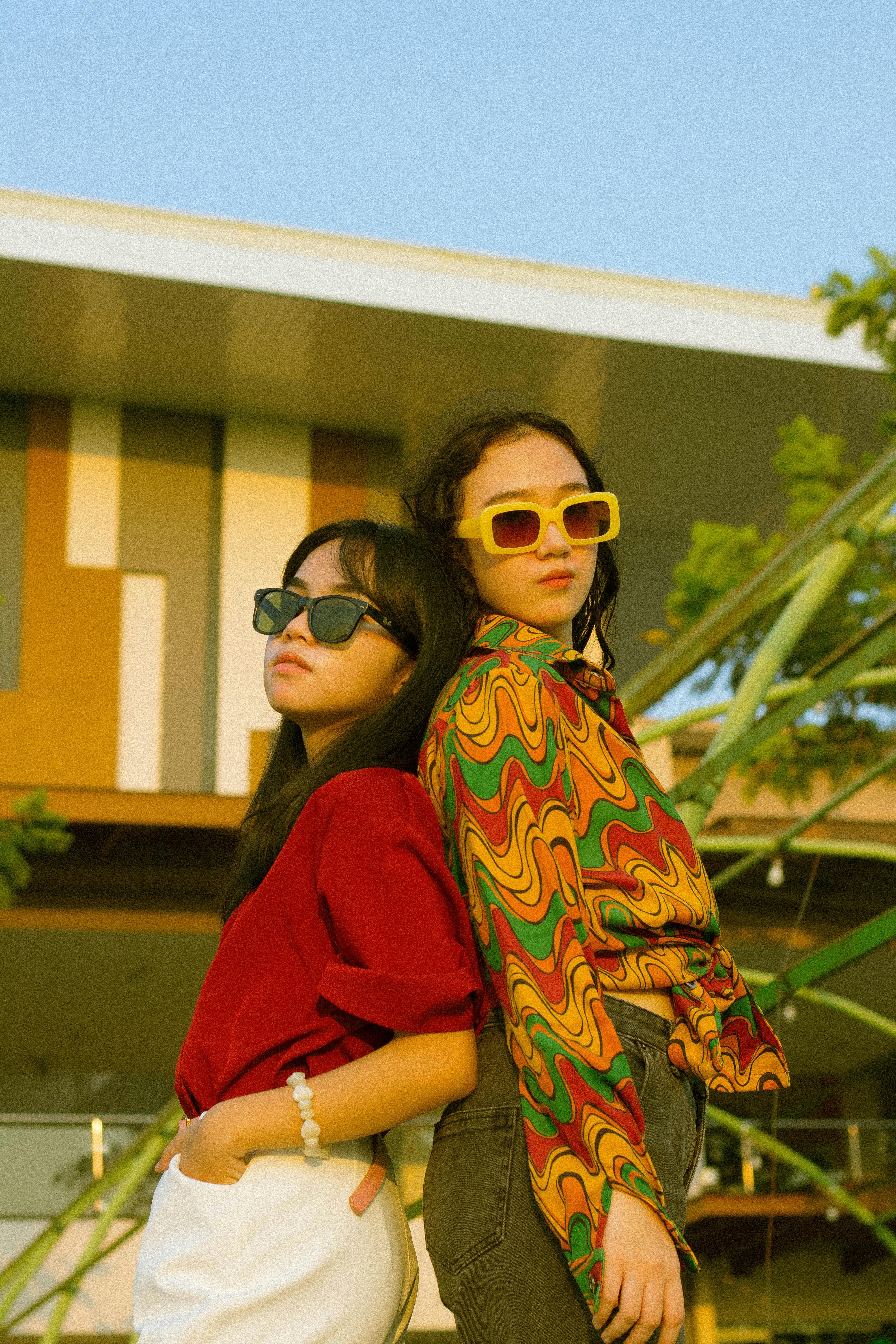 Two Girls Standing Back to Back · Free Stock Photo