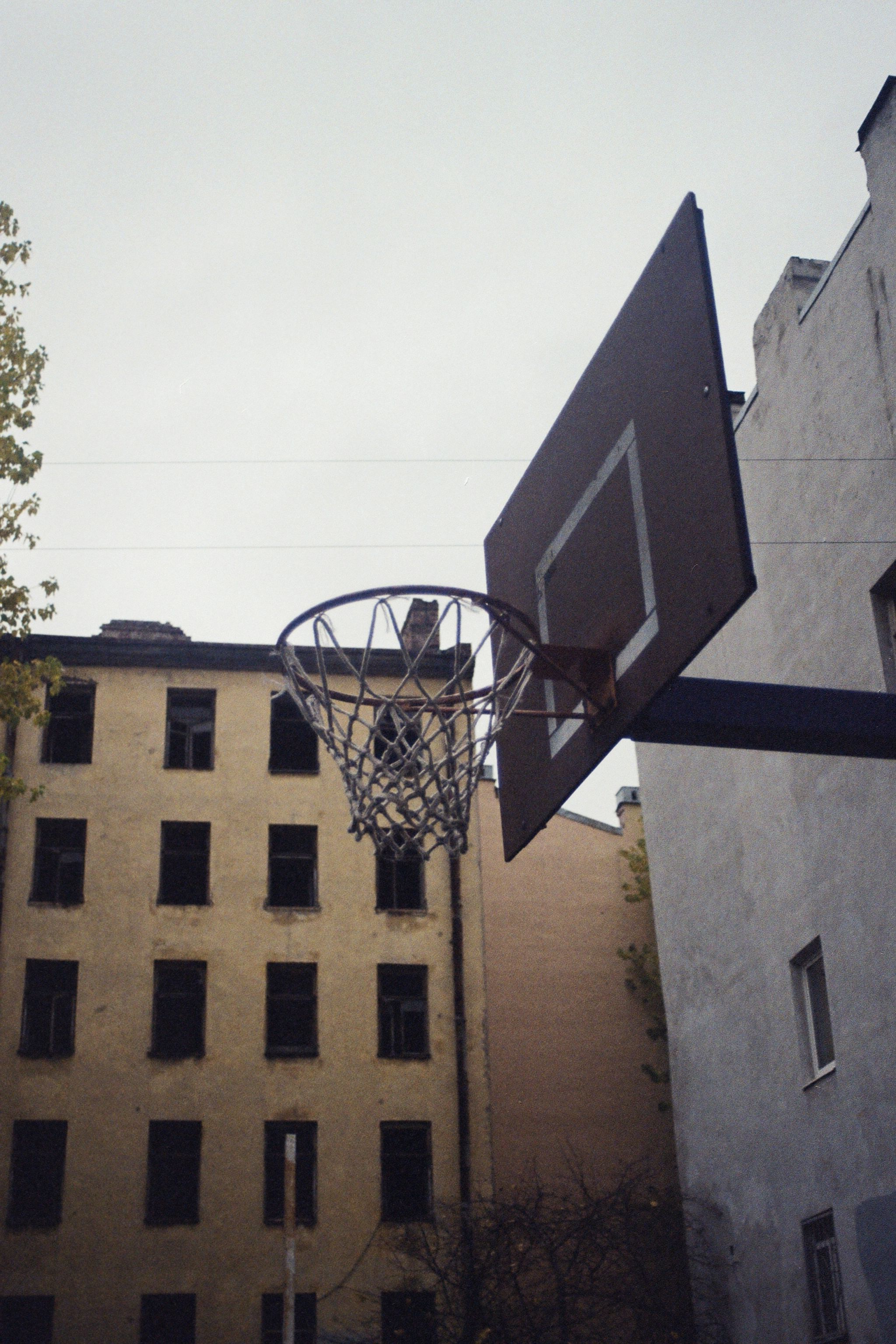 A Basketball Hoop Near Brown Concrete Building · Free Stock Photo