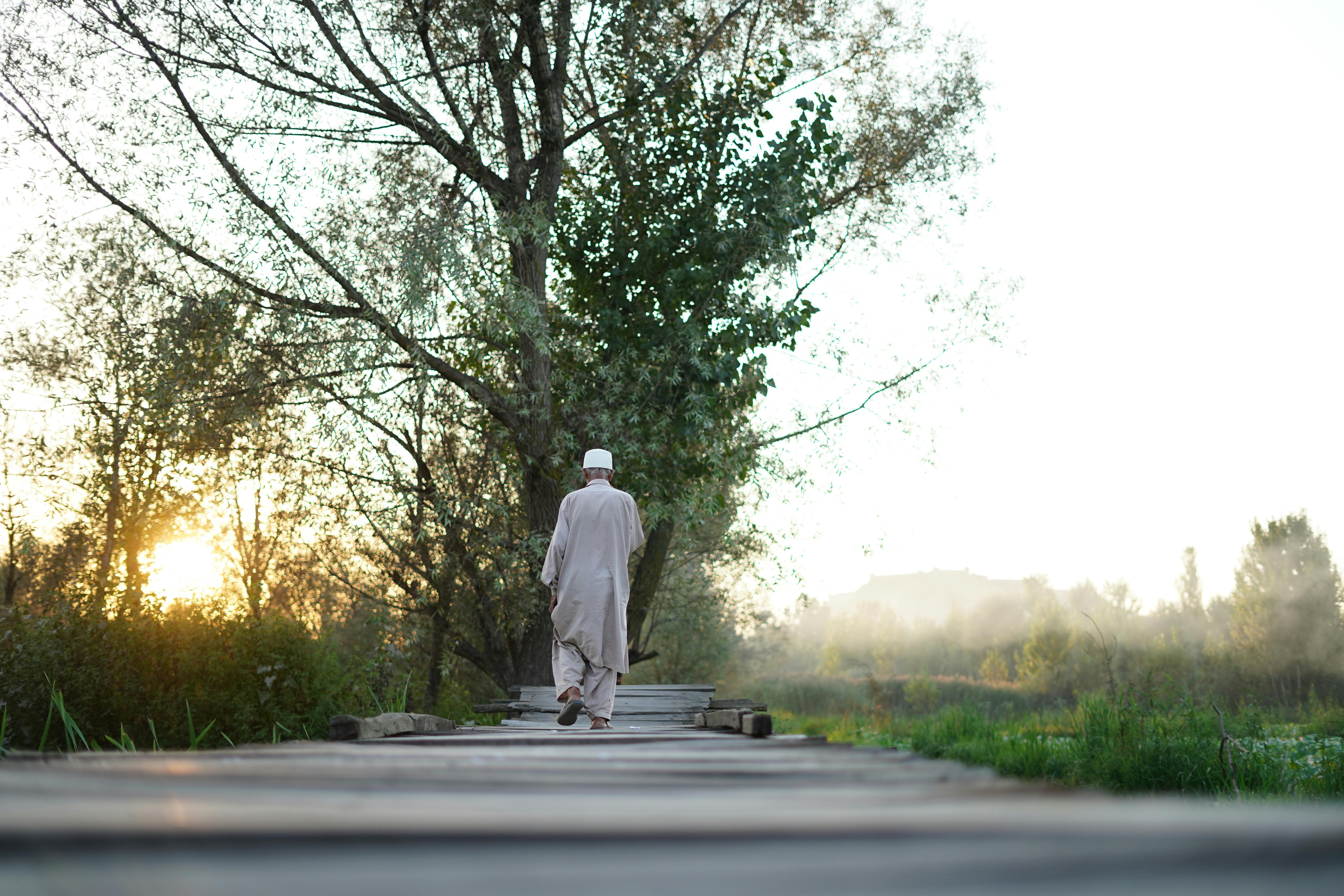 Man Walking on Pier at Sunrise · Free Stock Photo