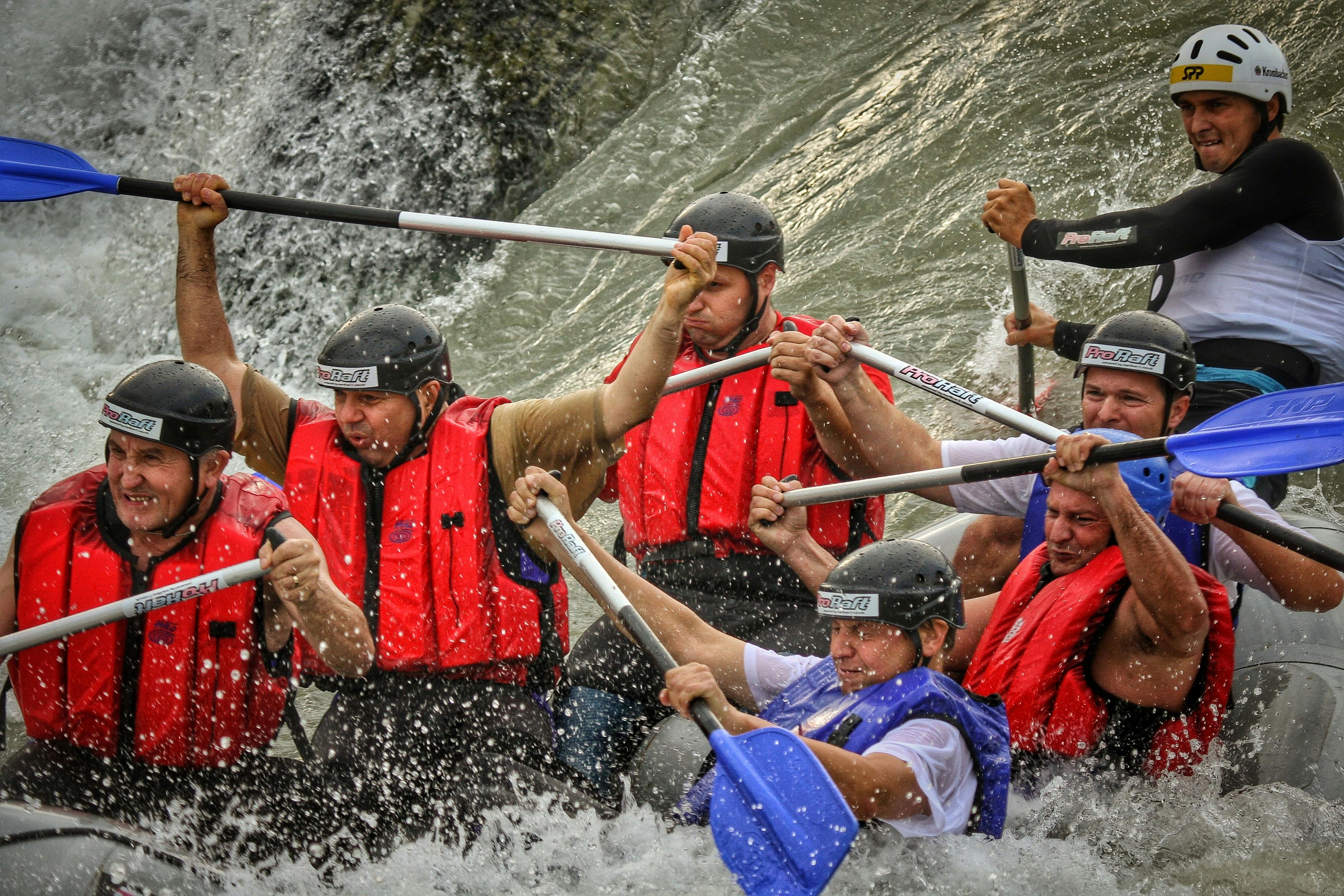 Three Persons Riding Red Inflatable Raft · Free Stock Photo