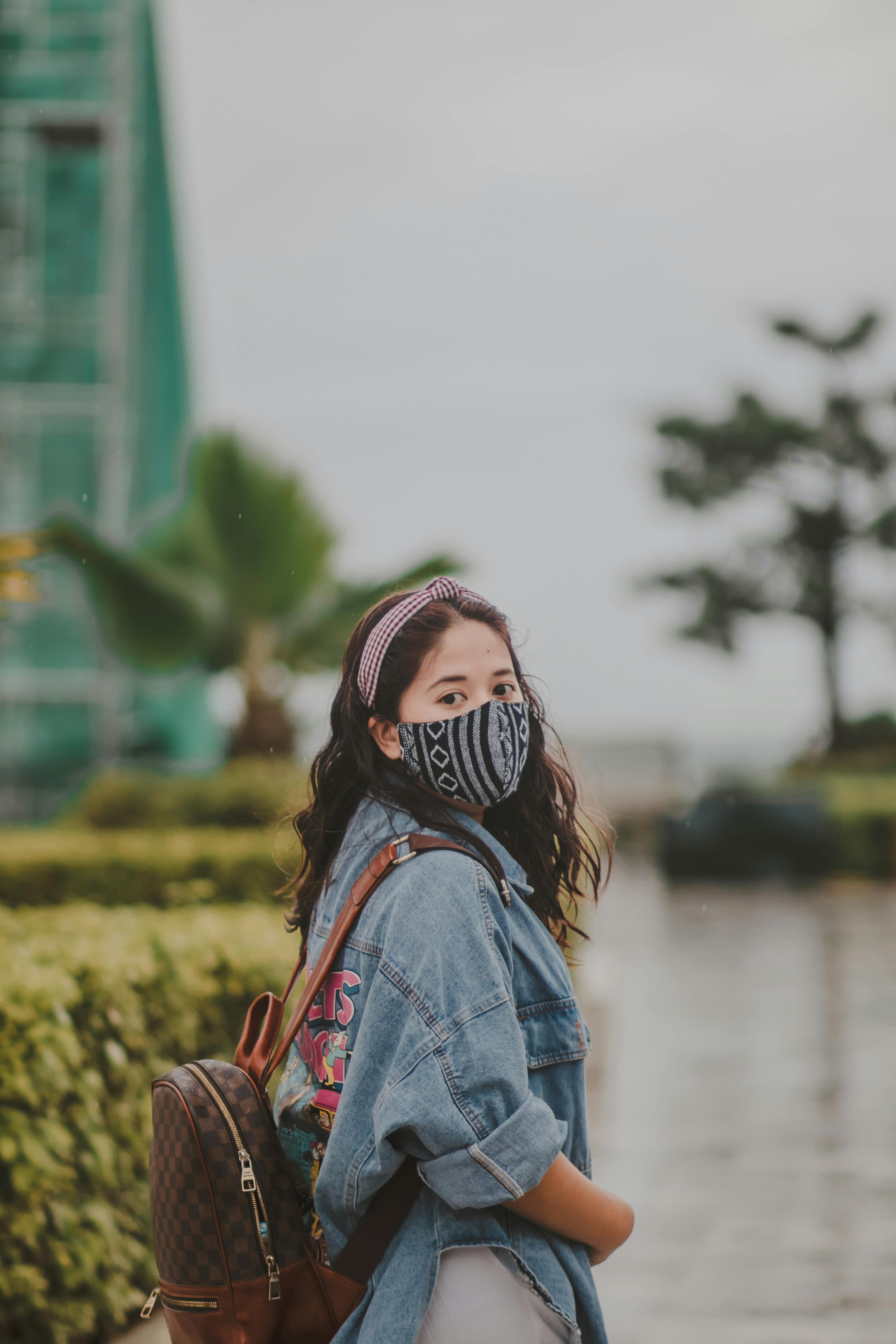 Close-Up Shot of a Woman Wearing a Denim Jacket · Free Stock Photo