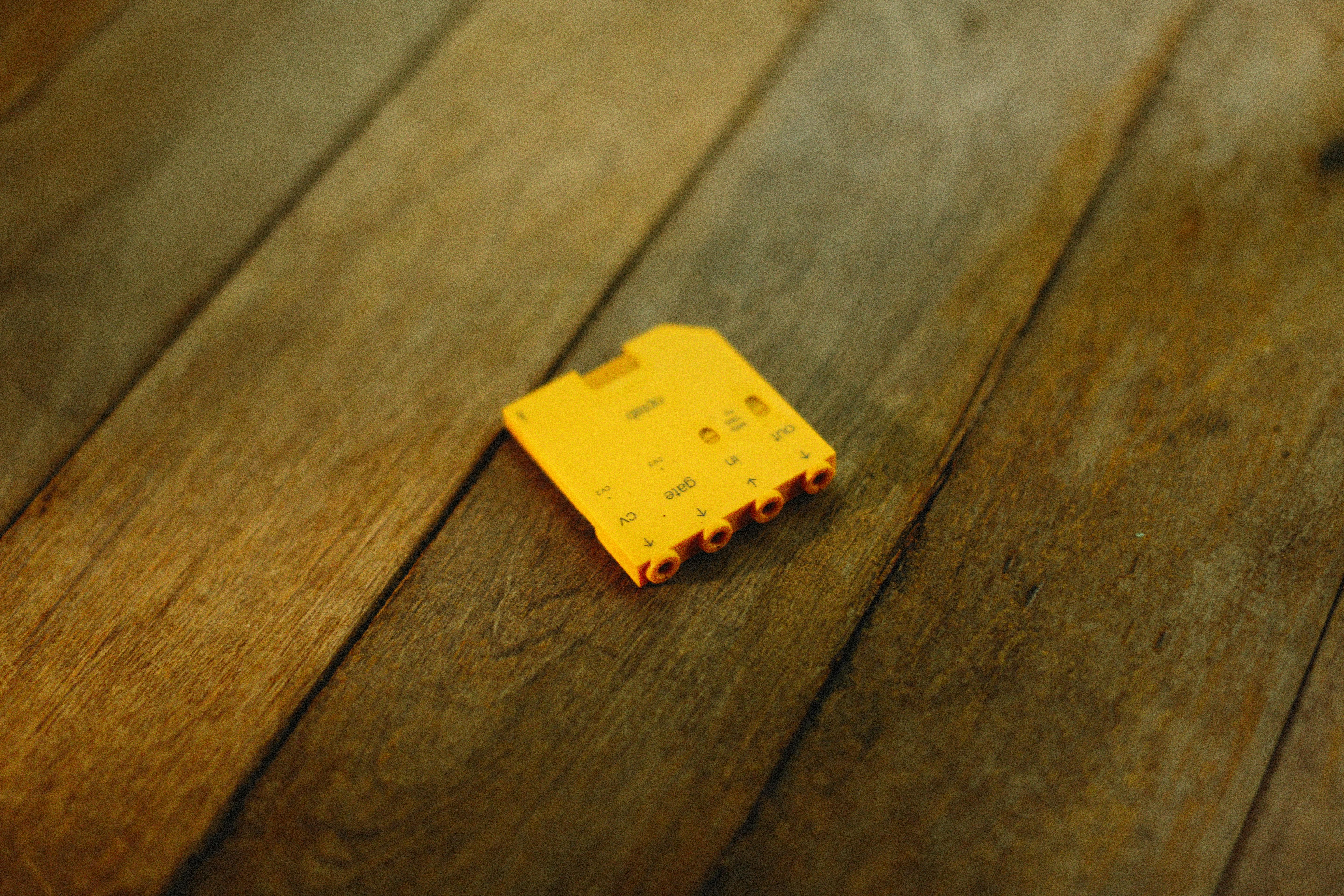 Yellow Device on Planks · Free Stock Photo