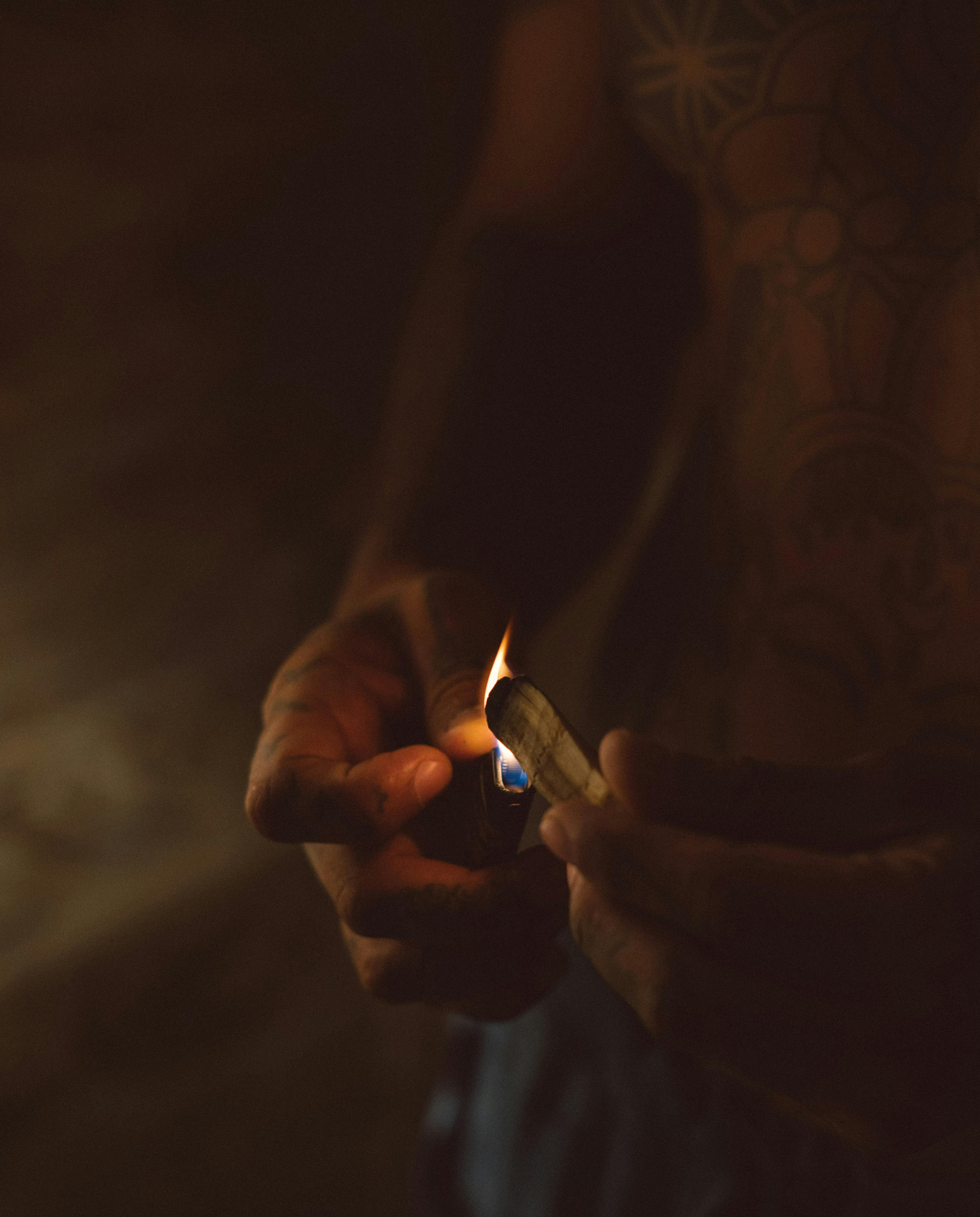Person Lighting a Candle Using a Lighter · Free Stock Photo
