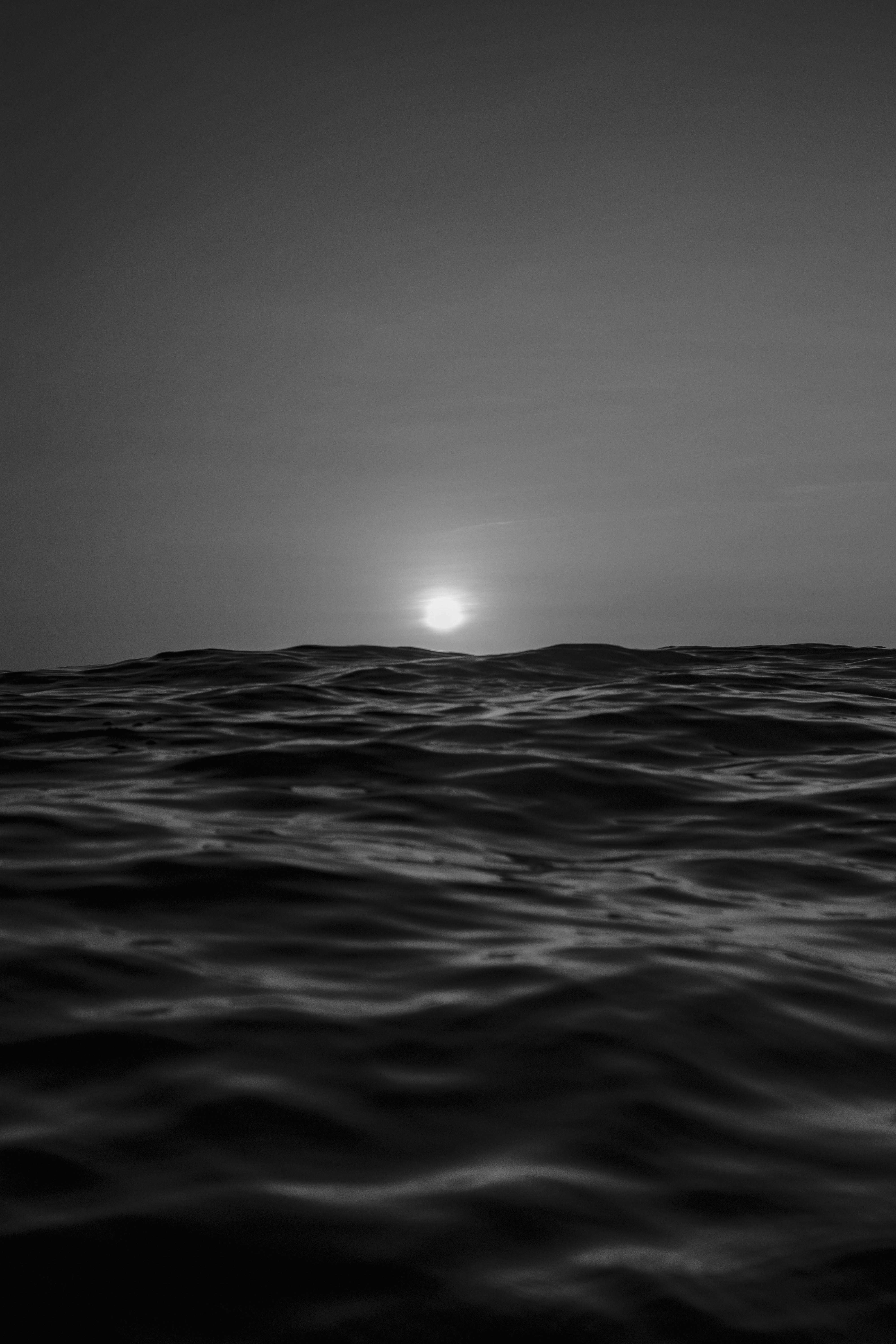 Grayscale Photo of Ocean Waves with View of Moon · Free Stock Photo