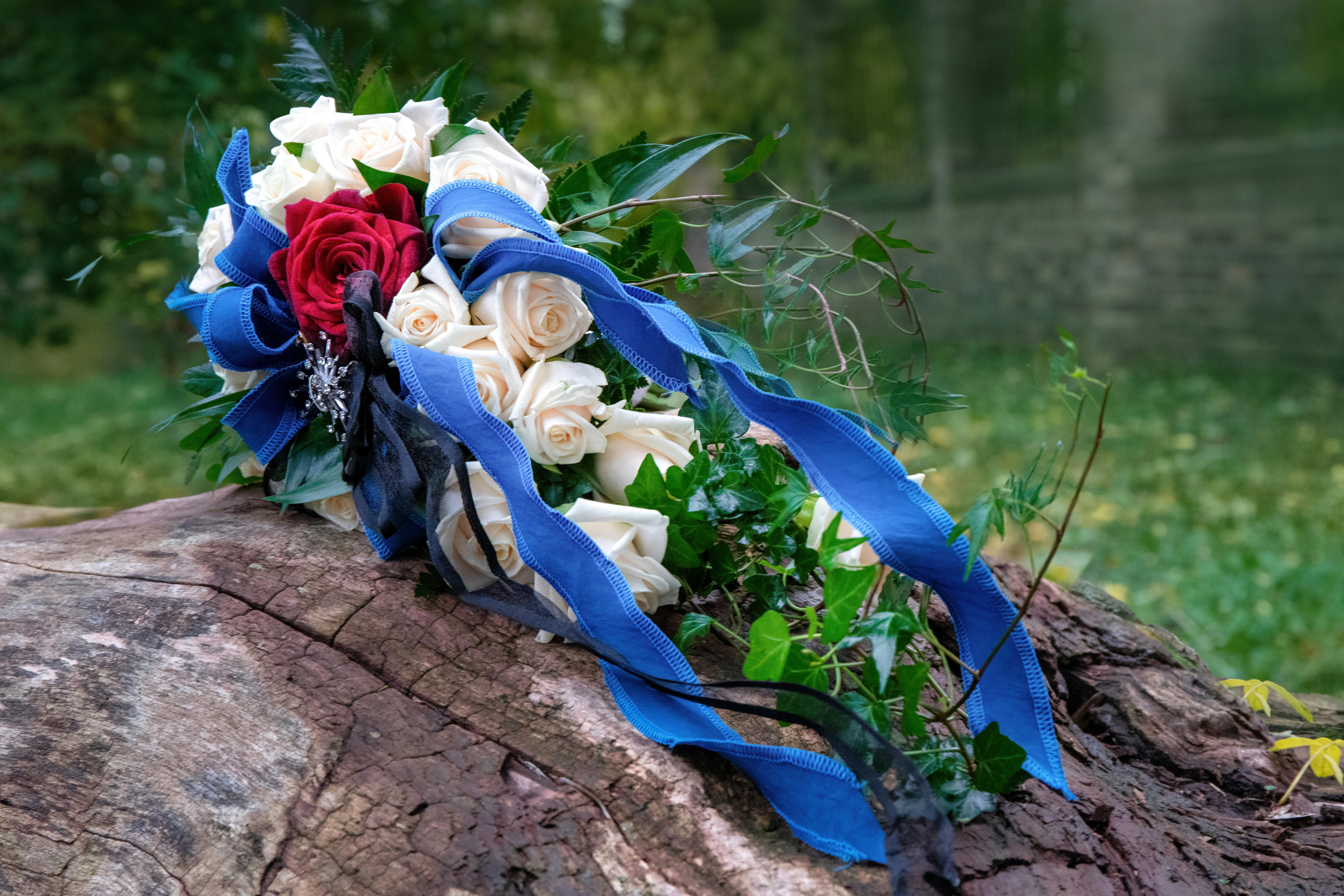 Bouquet of Flowers on a Tree Log · Free Stock Photo