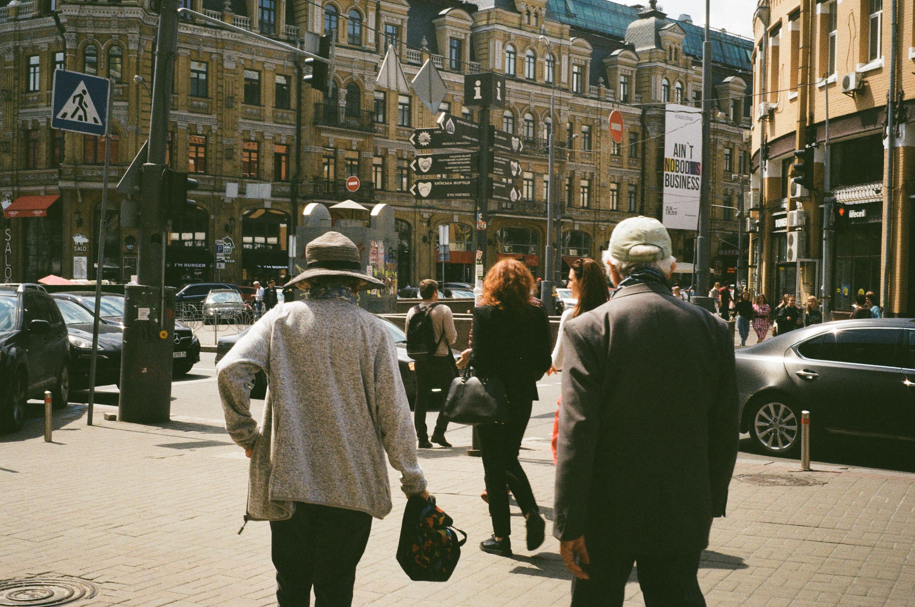 People Walking on Street Between High Rise Building · Free Stock Photo