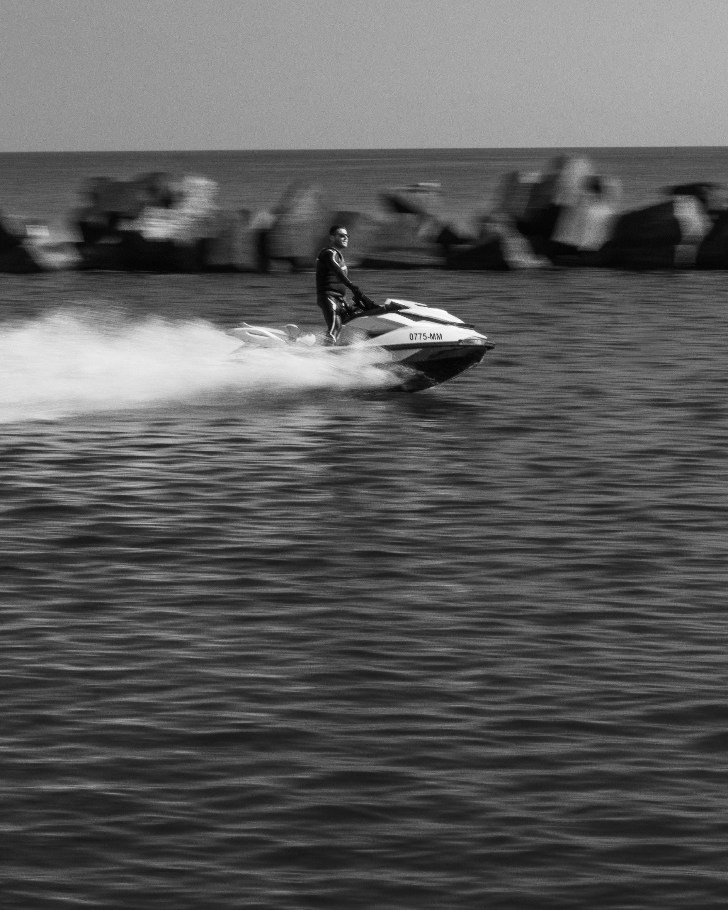 Grayscale Photo of People Doing Flyboarding · Free Stock Photo