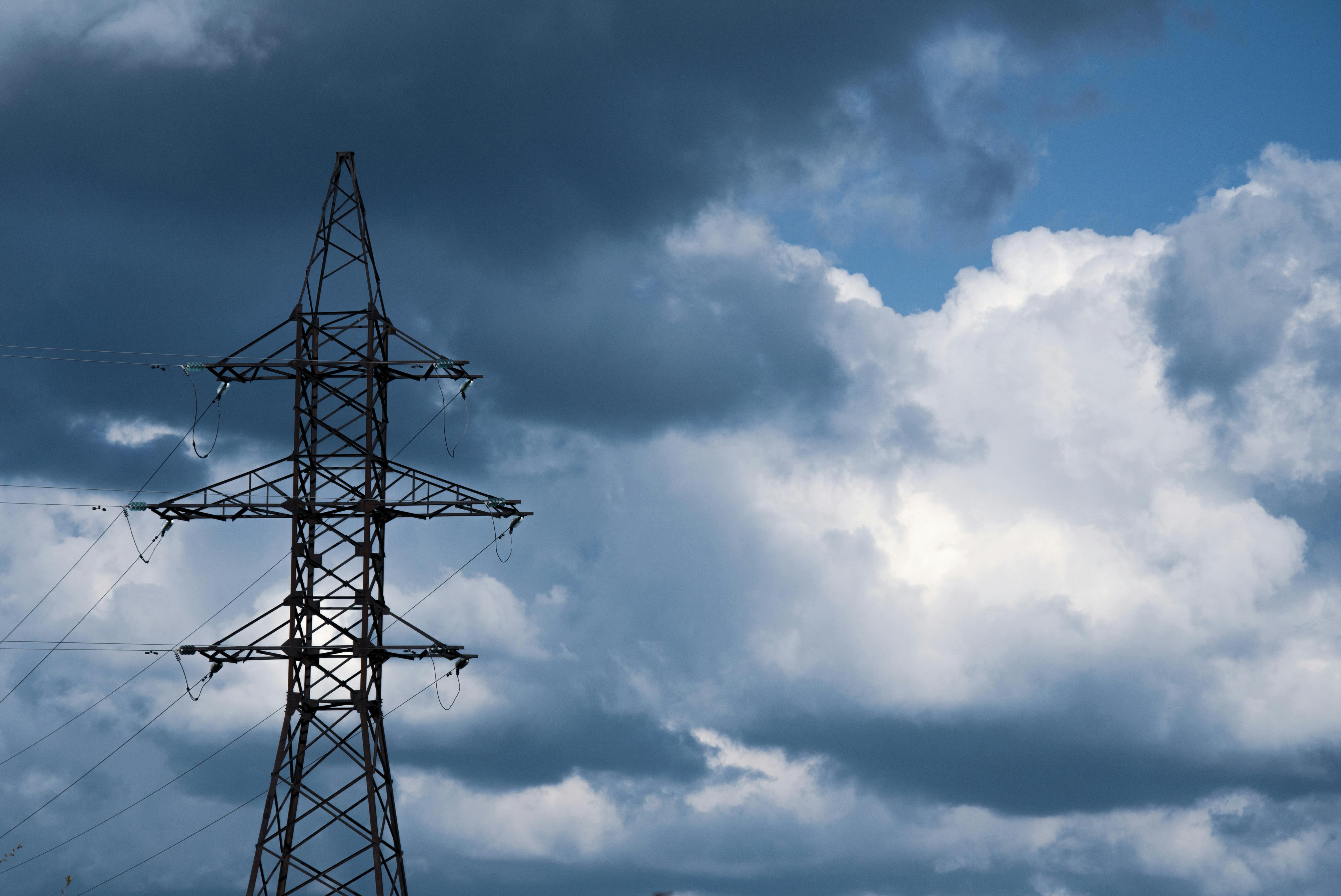 A Transmission Tower Near White Clouds · Free Stock Photo