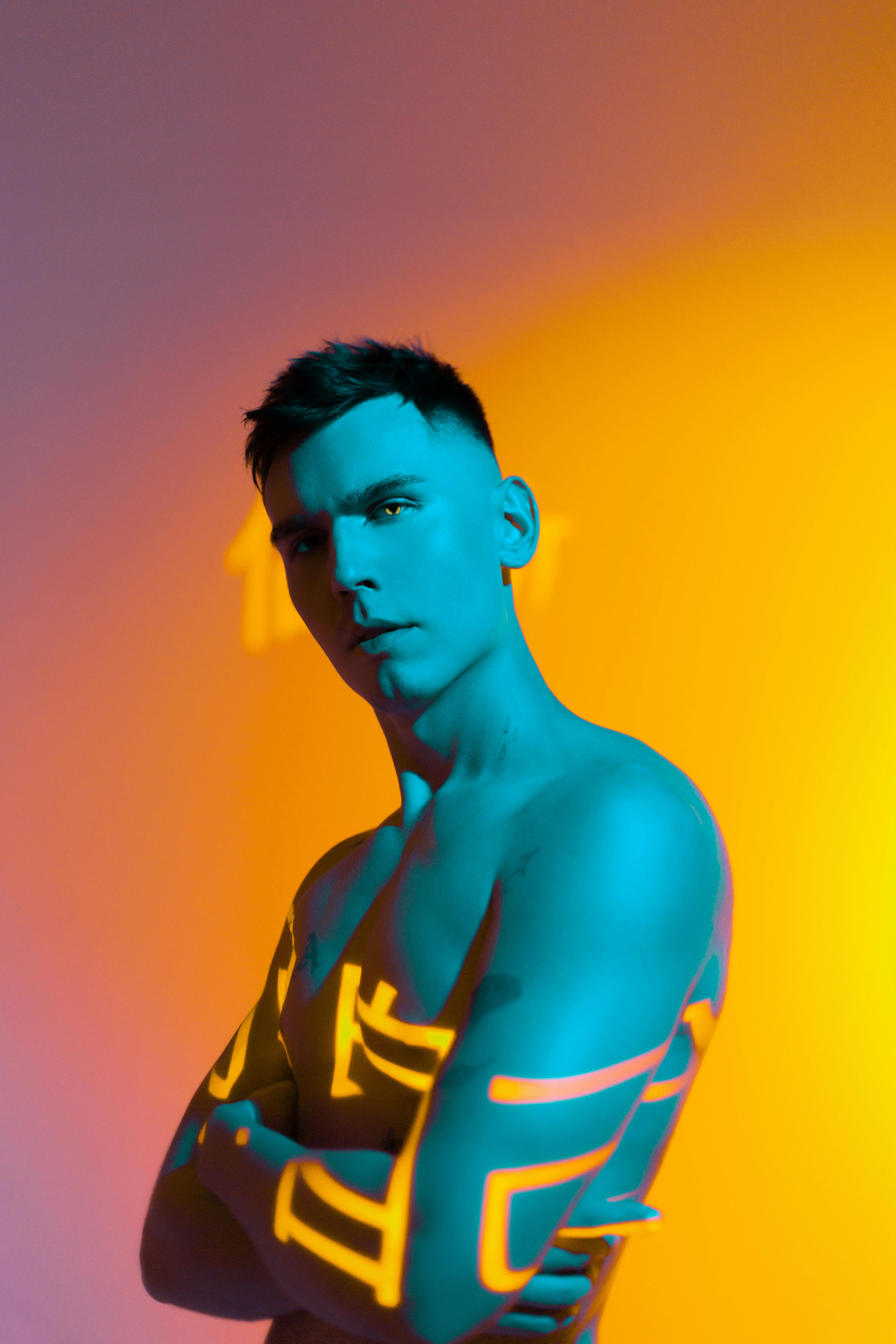 Man Covered With Blue Paint Near Body of Water · Free Stock Photo