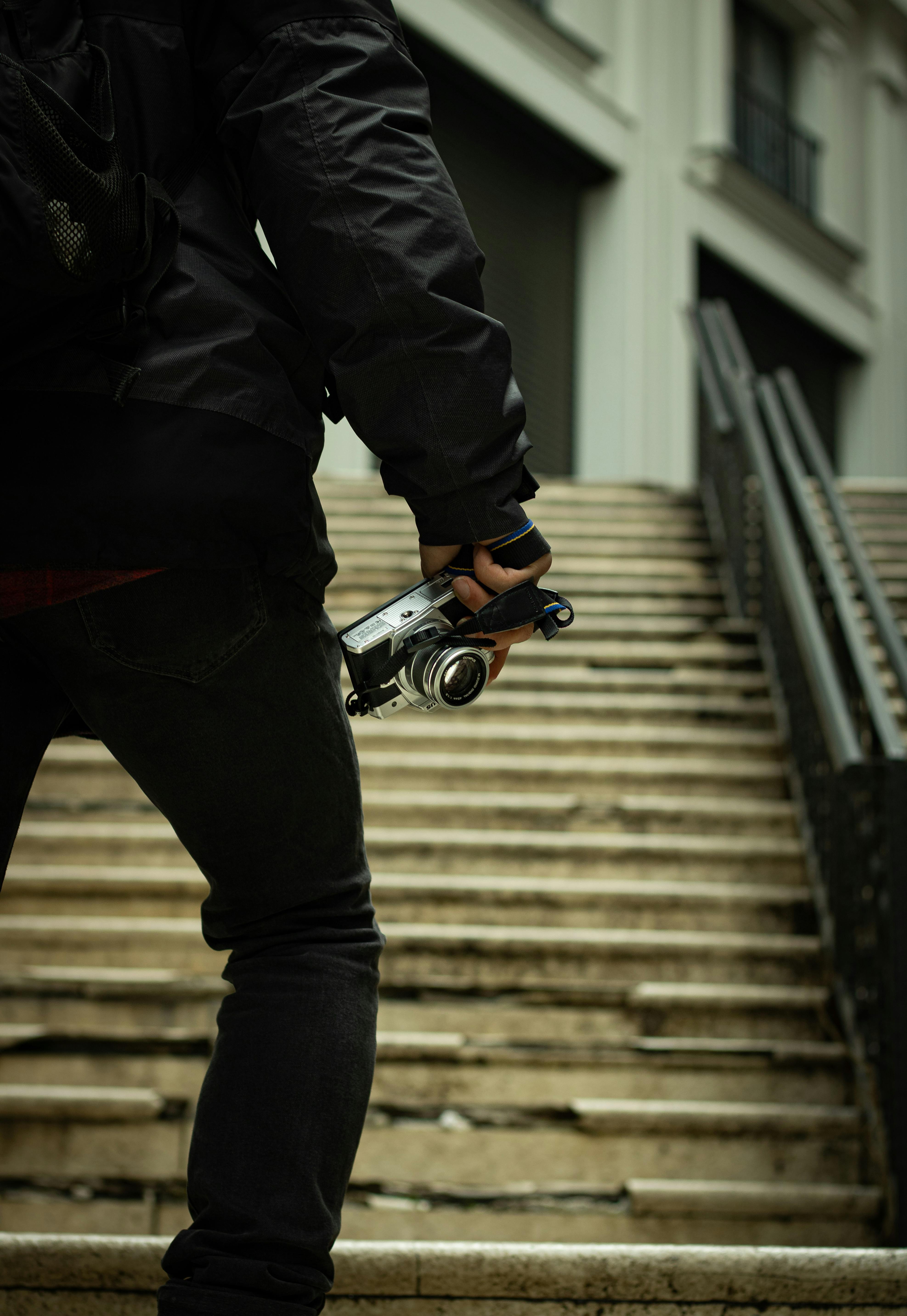 Man walking down the old stone staircase · Free Stock Photo