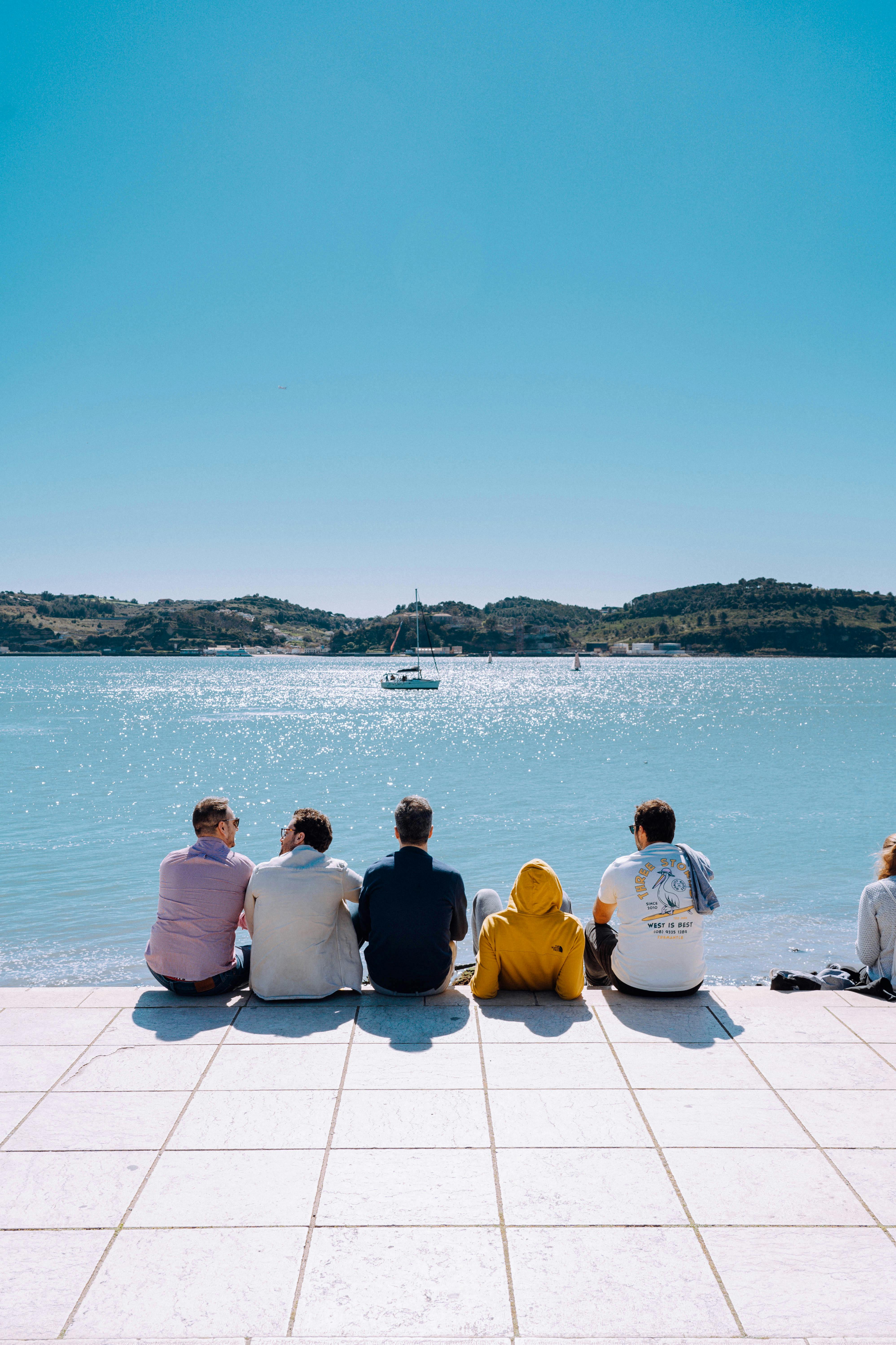 Photo of Man Sitting on Dock · Free Stock Photo