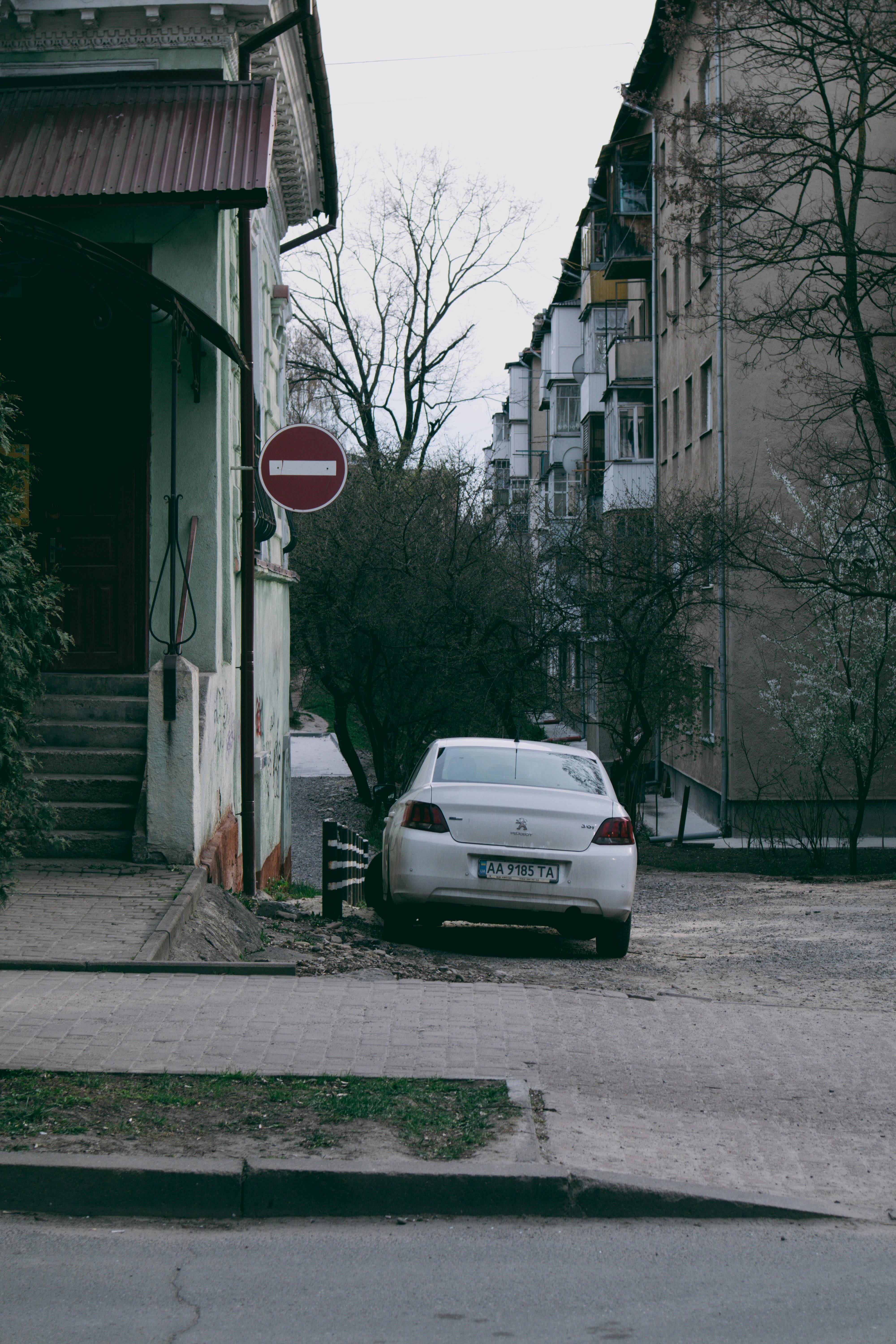 White Car Parked Beside a Family House · Free Stock Photo