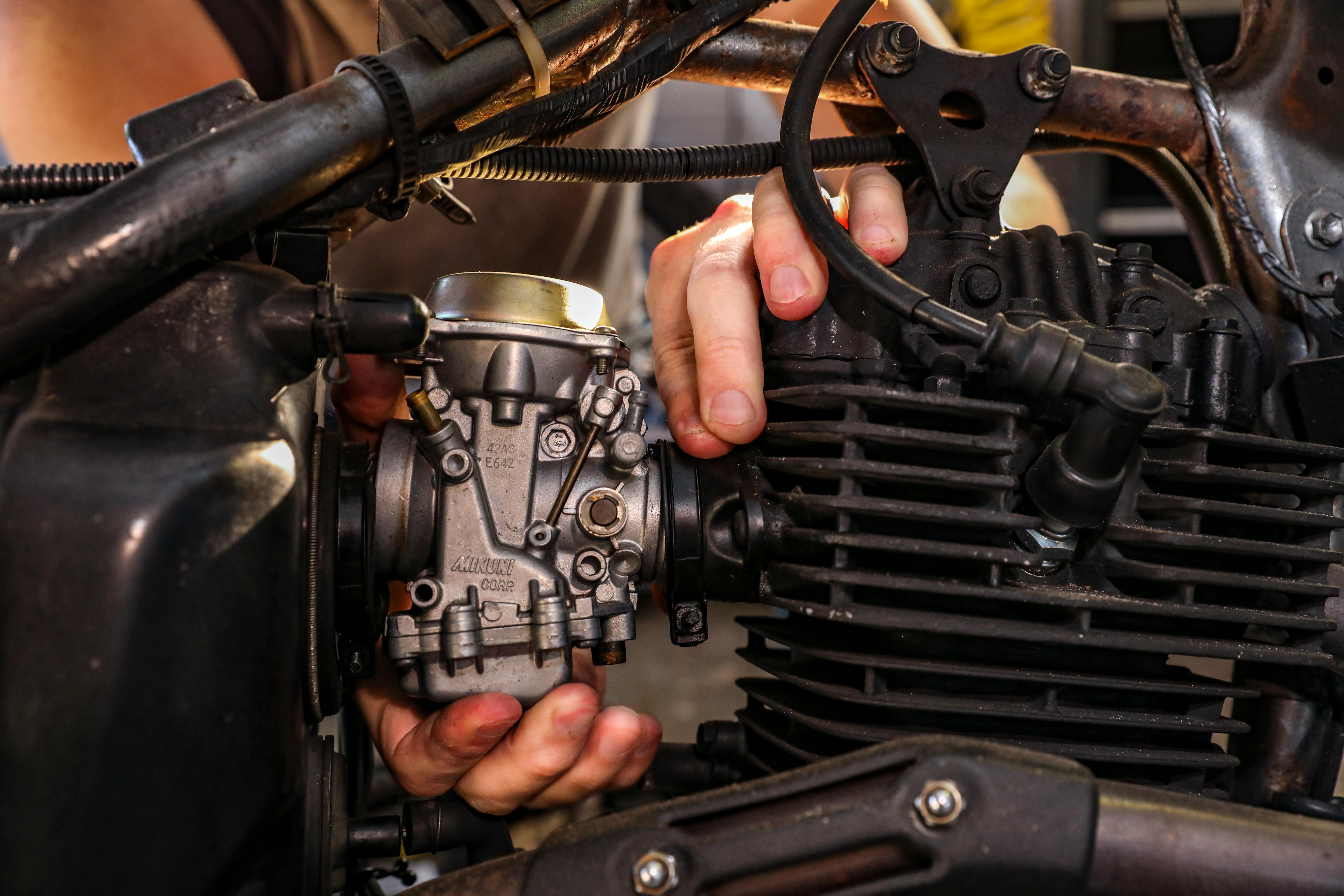 Close-Up Shot of a Person Fixing an Engine of a Motorcycle · Free Stock ...