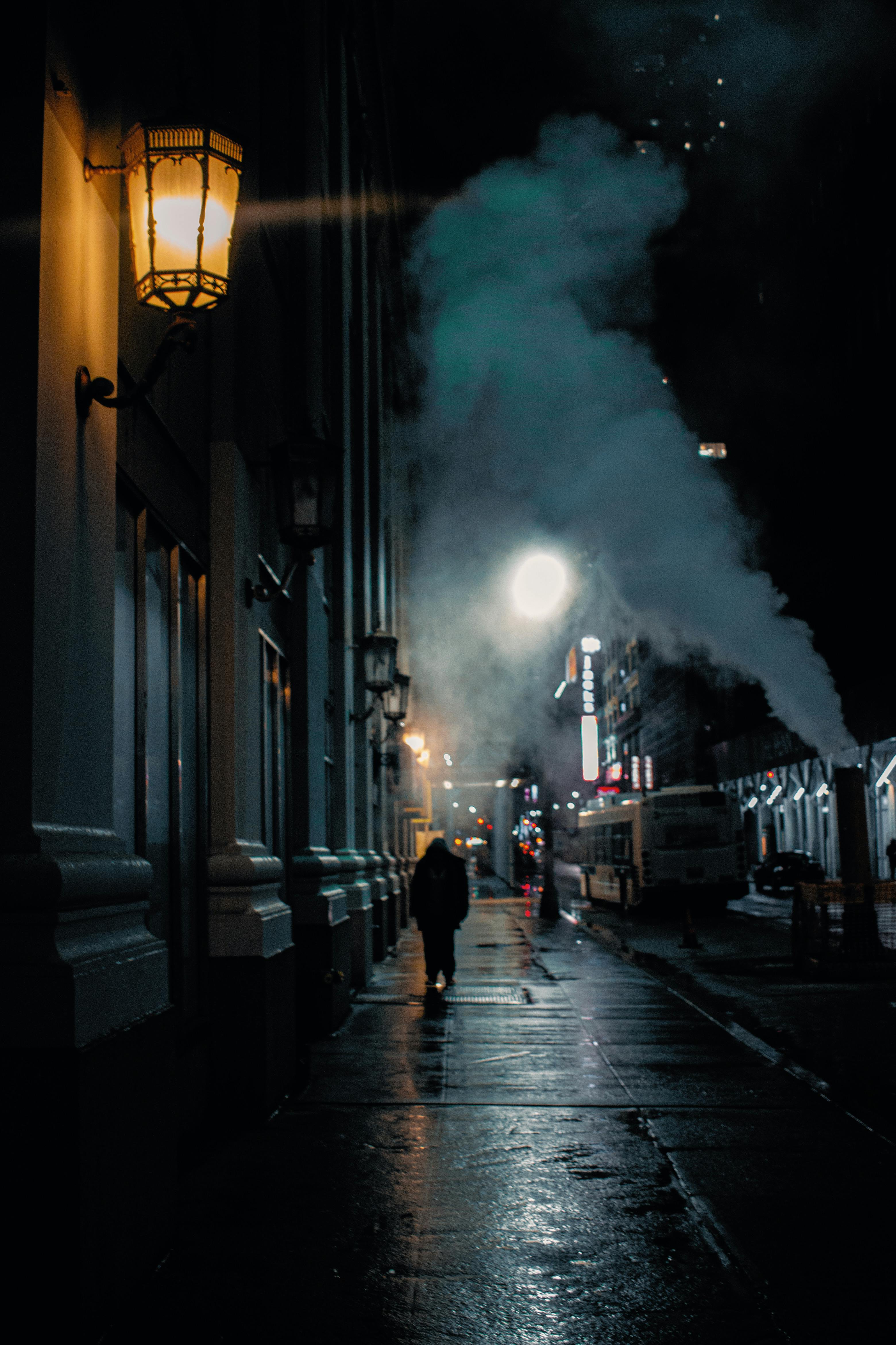 Person Walking on a Street at Night · Free Stock Photo