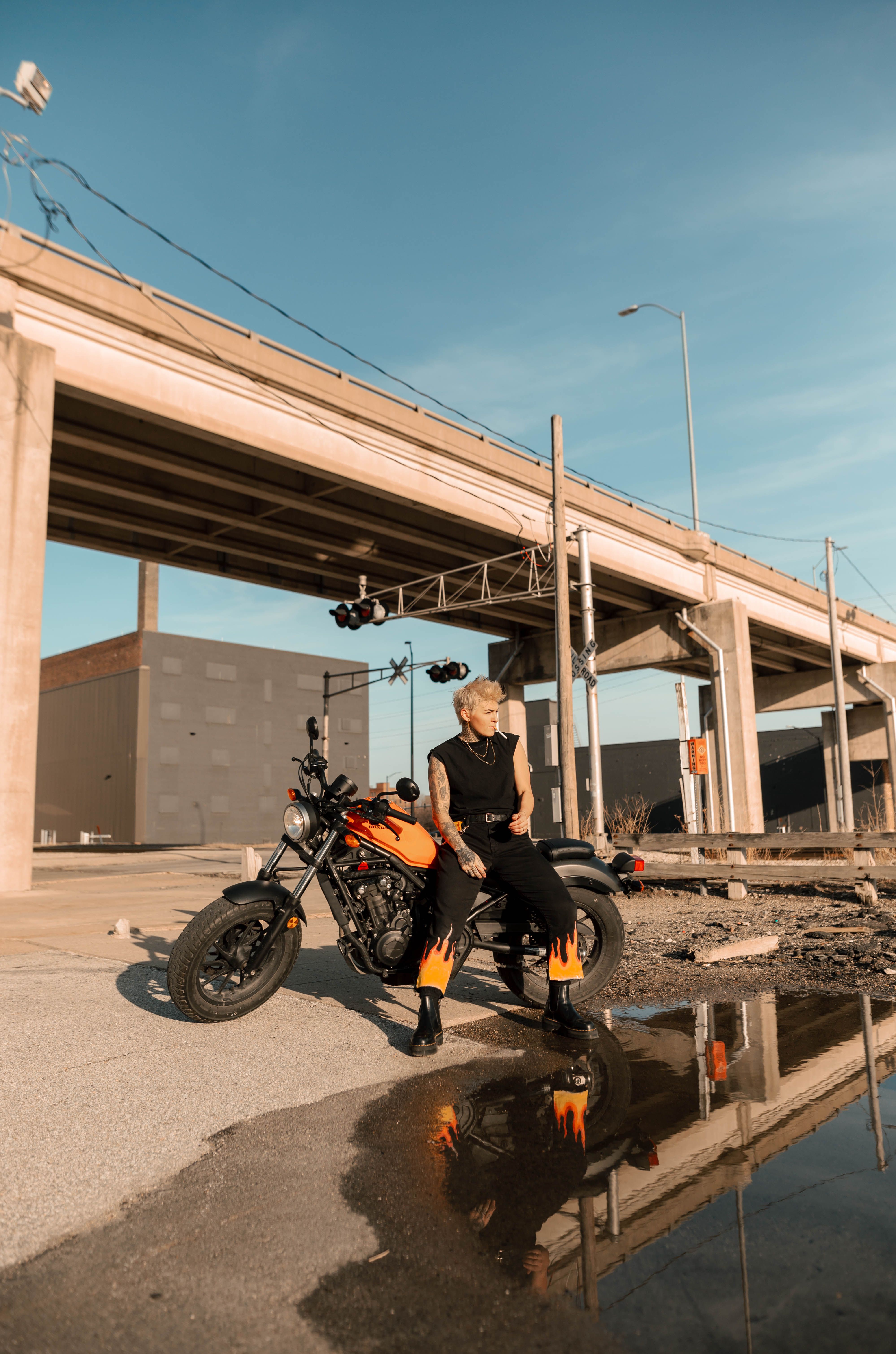 A Woman Lying on a Motorcycle · Free Stock Photo