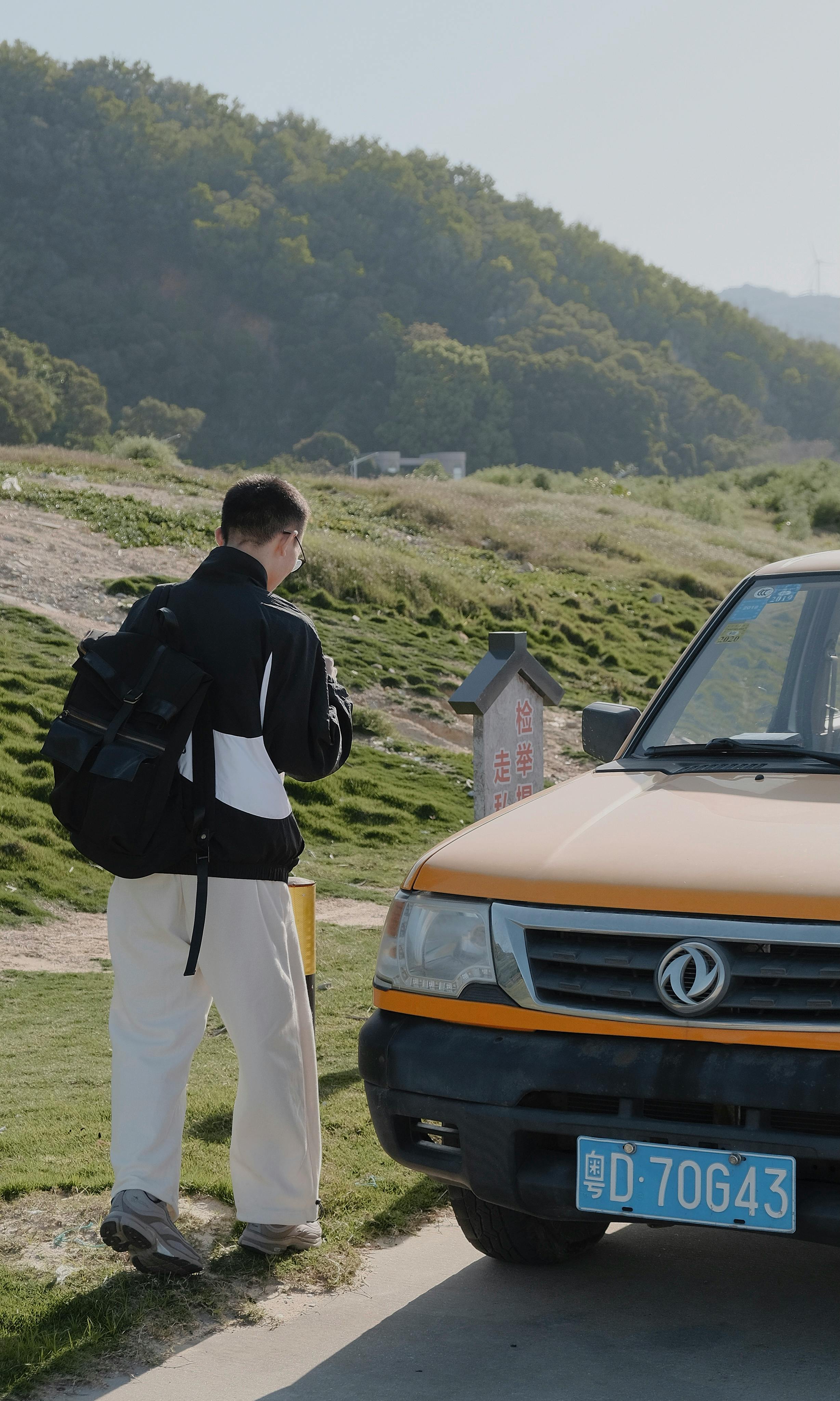 Photo of a Man Posing in Front of a White Car · Free Stock Photo