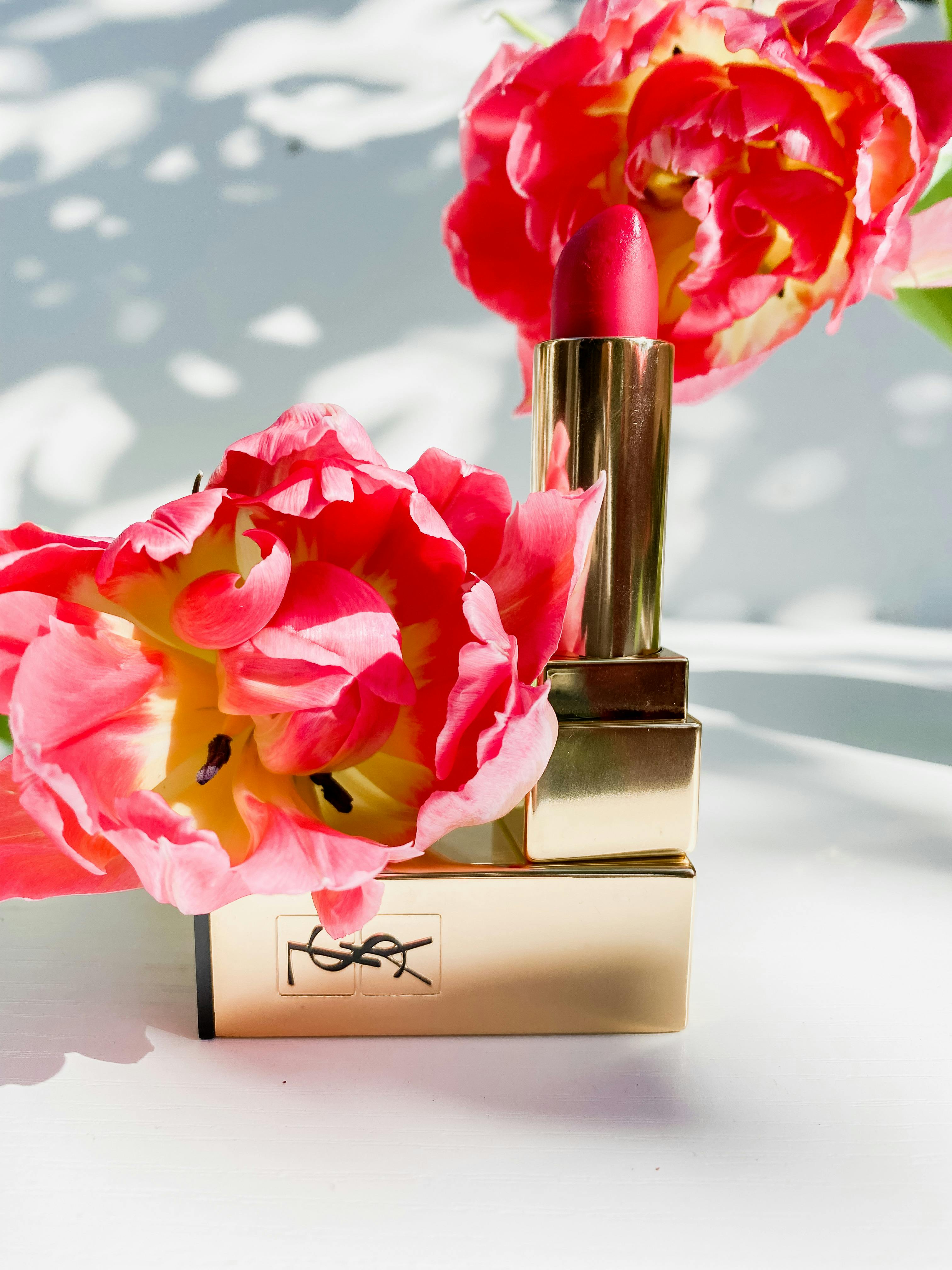 Close-Up Photo of a Lipstick Near Flowers · Free Stock Photo