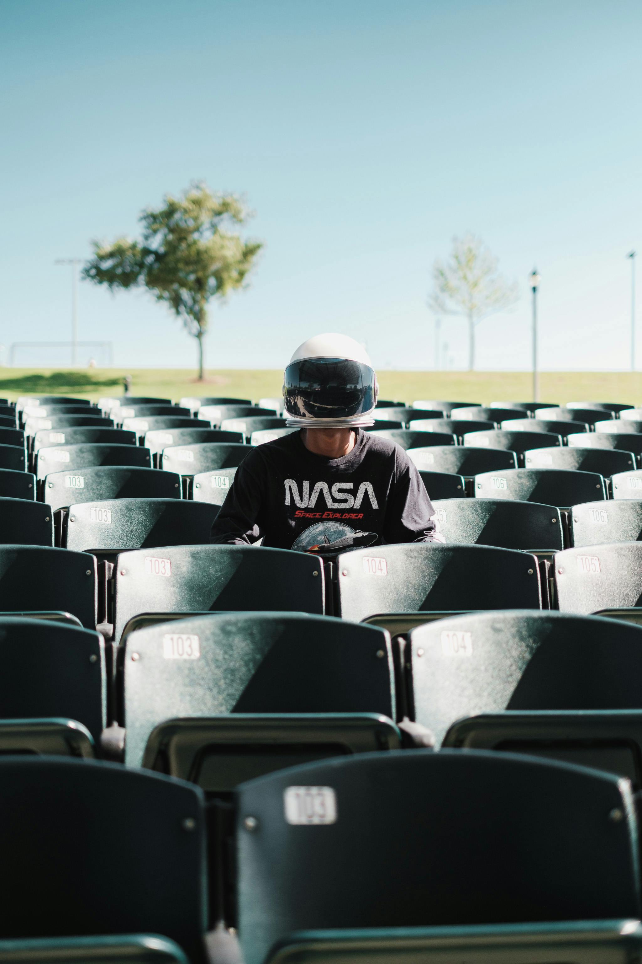 Man Sitting on Seats in Sunlight · Free Stock Photo