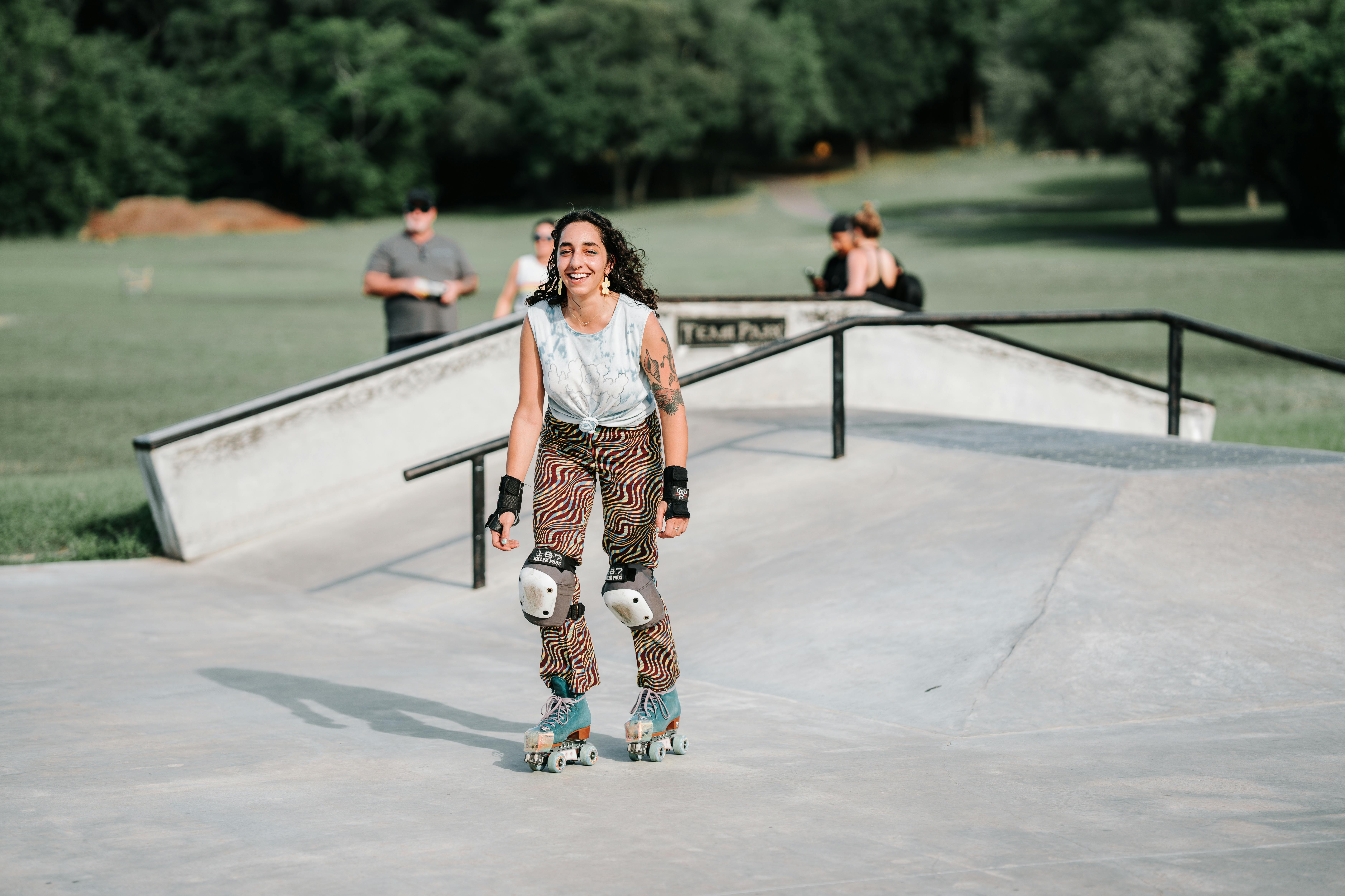 Woman Sitting on Handrail with Roller Skates · Free Stock Photo