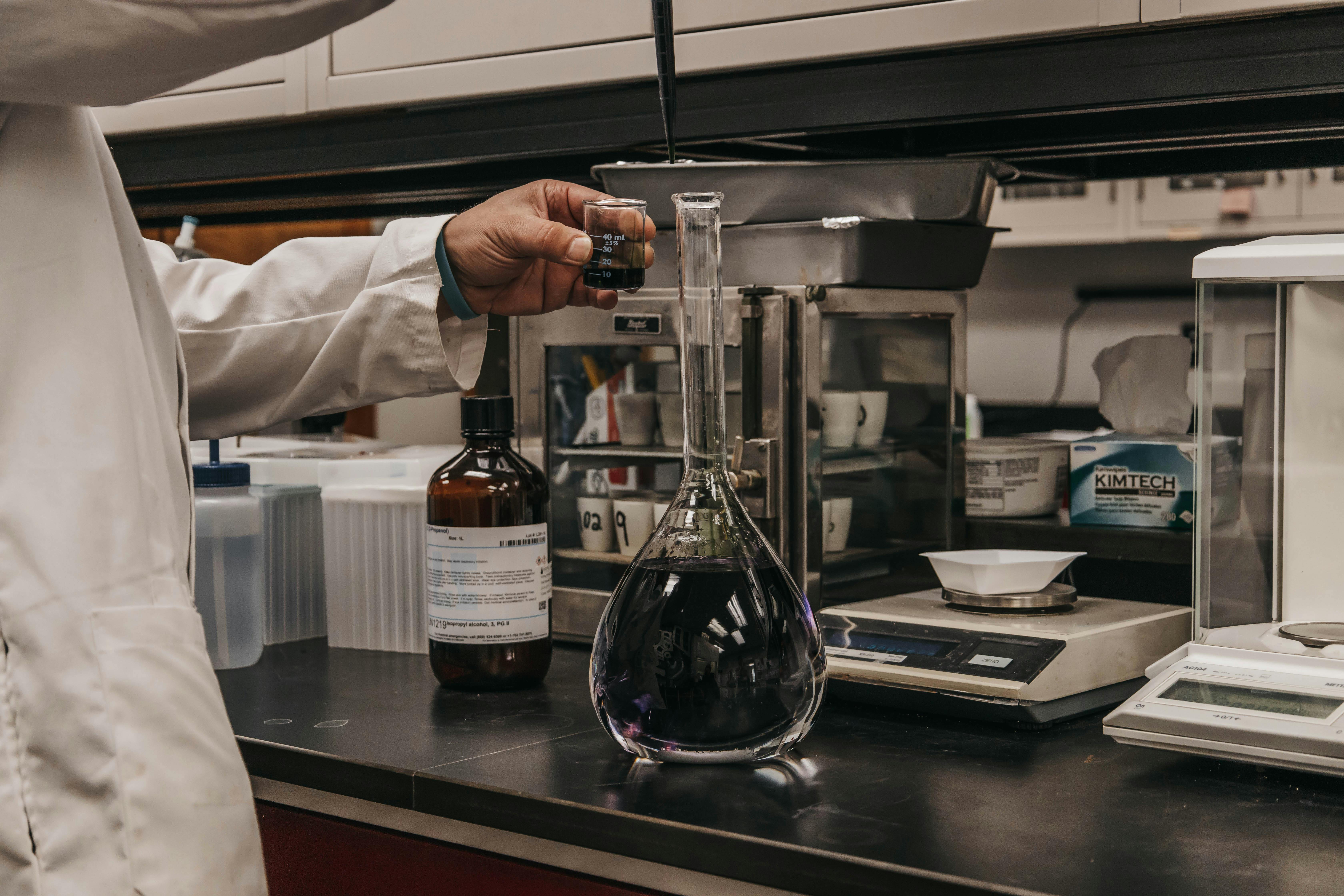 A Person Holding a Small Beaker · Free Stock Photo