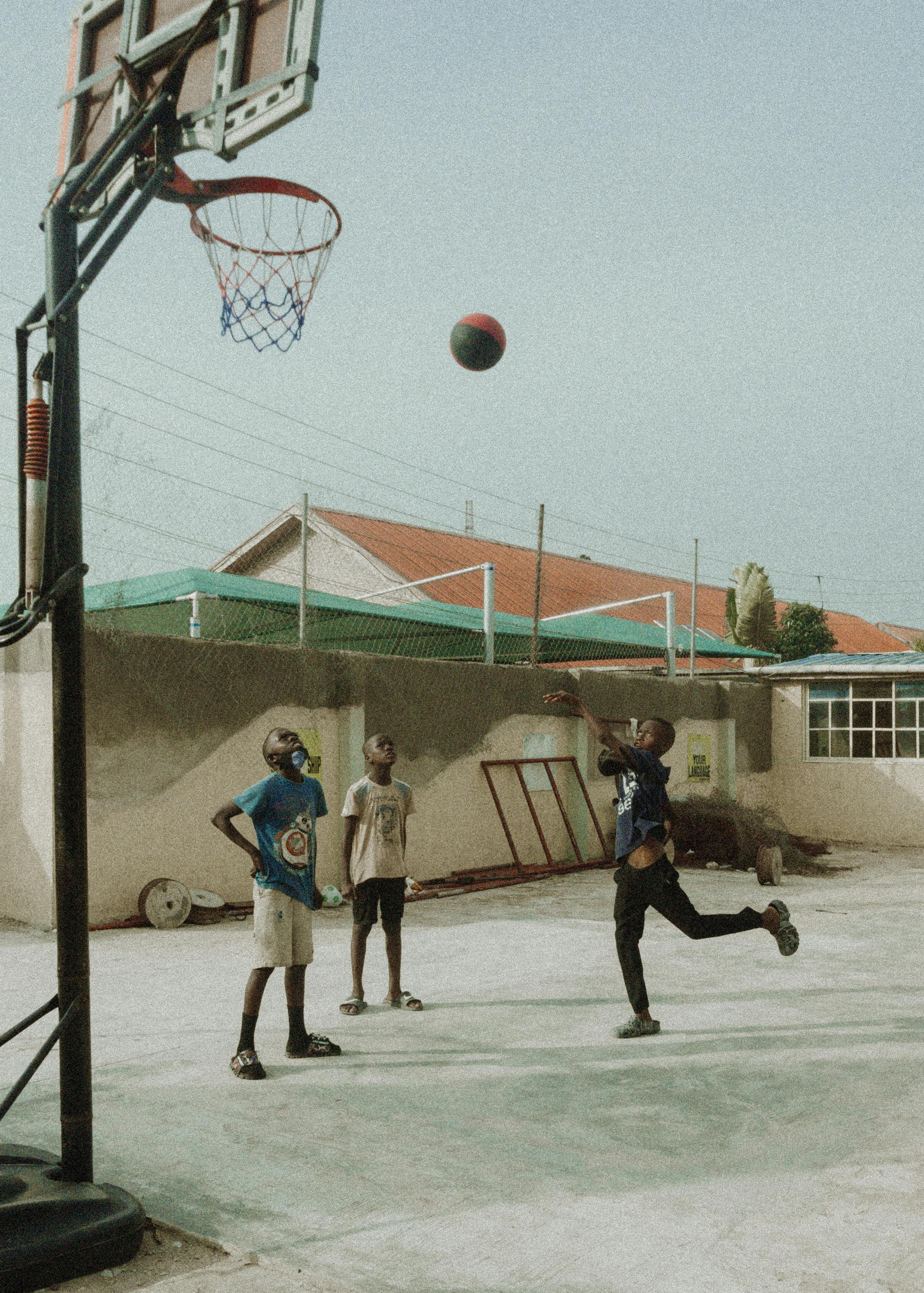 Photo of Boy Playing Basketball Alone in Open Court · Free Stock Photo