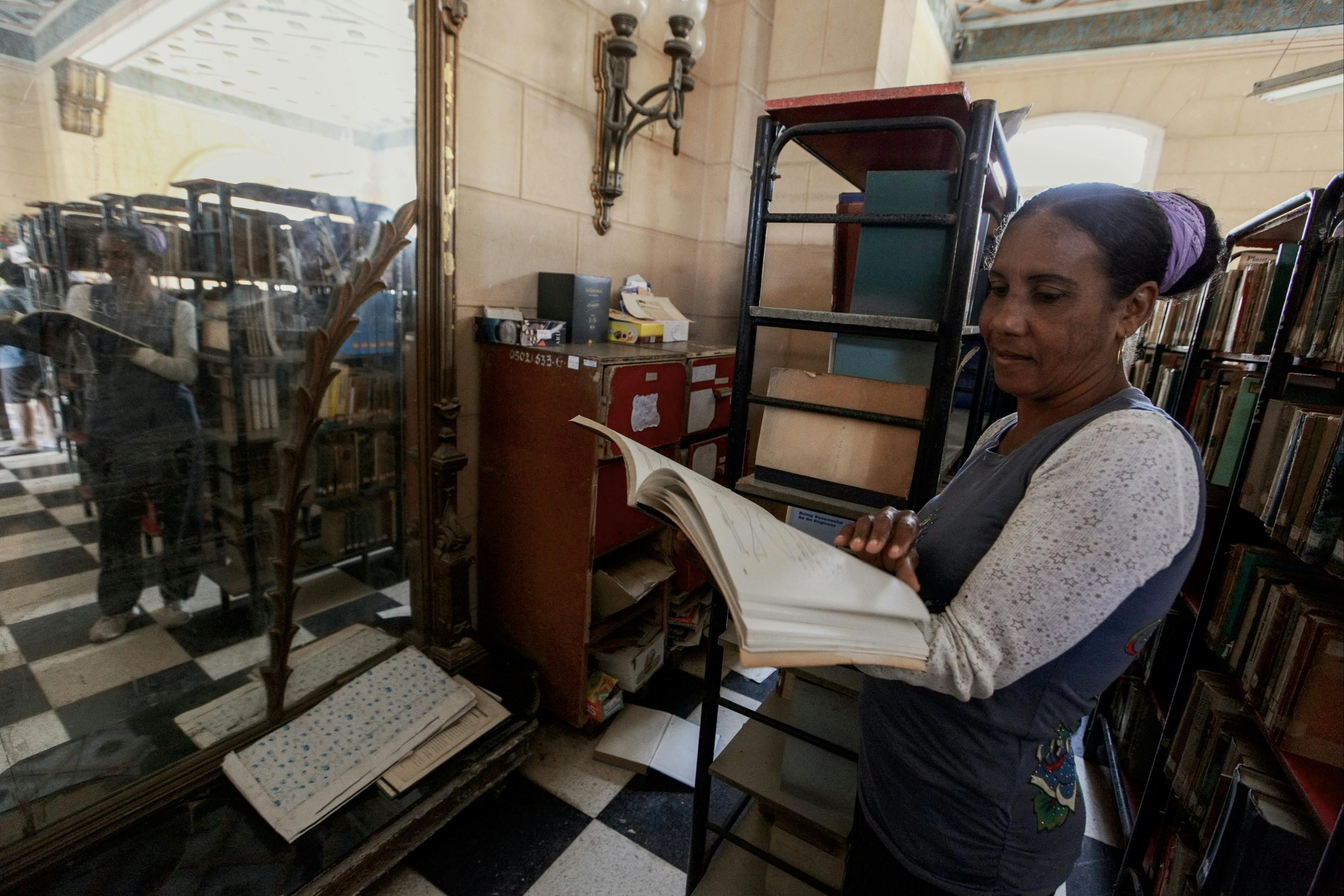 A Woman Reading a Book while Standing · Free Stock Photo