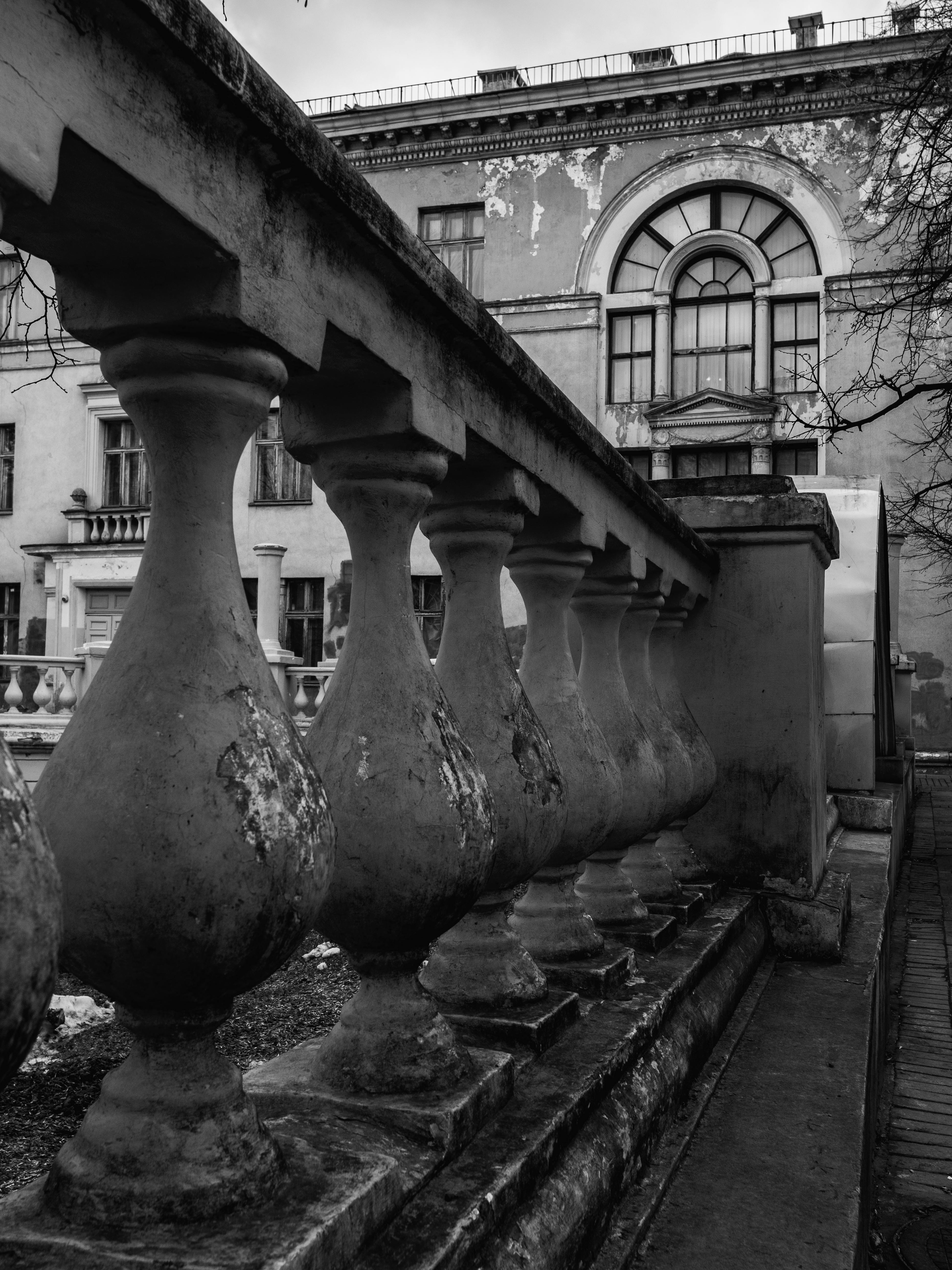A White Concrete Pillar in Grayscale Photography · Free Stock Photo