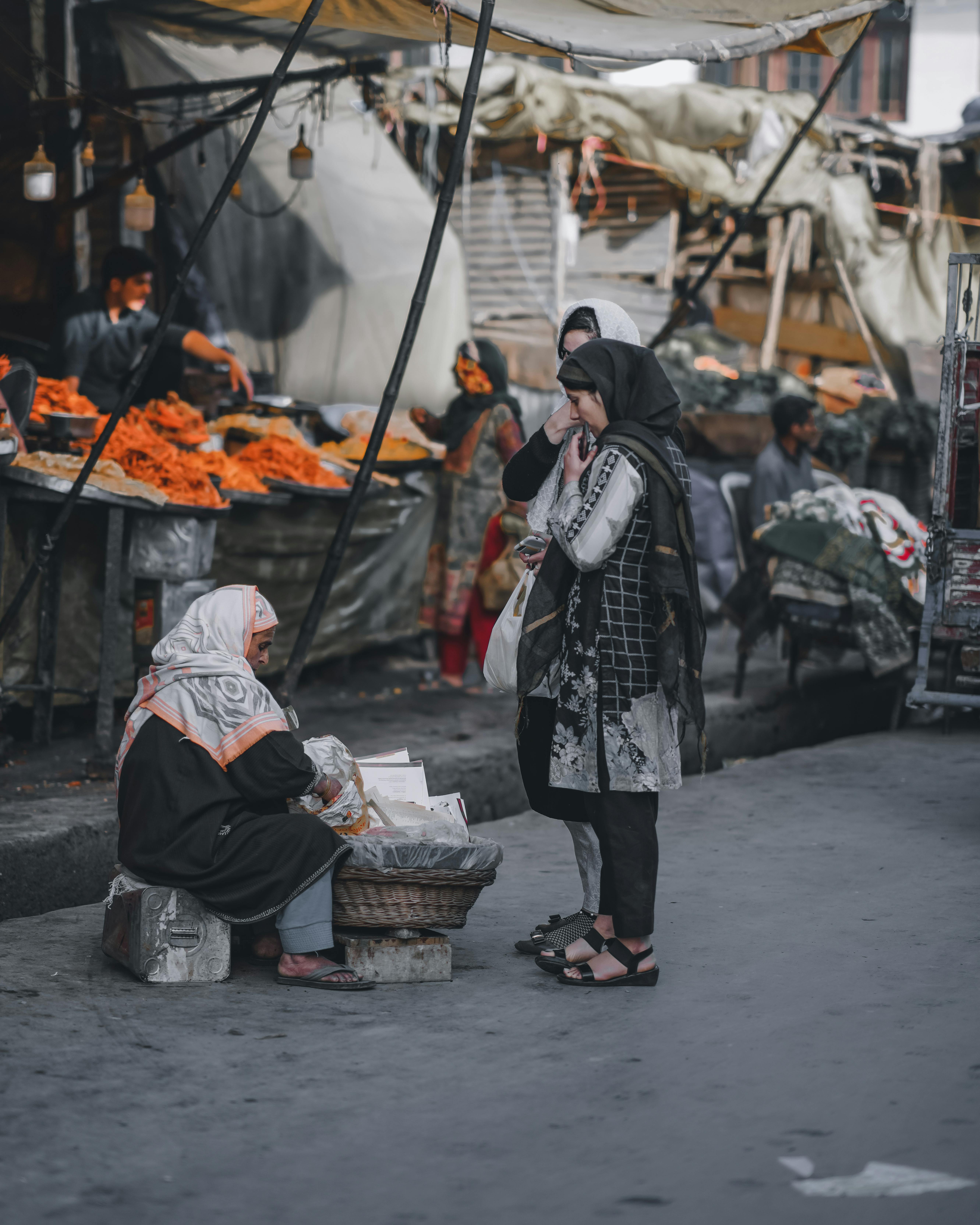 Woman Standing Near the Roadside Street Vendor · Free Stock Photo