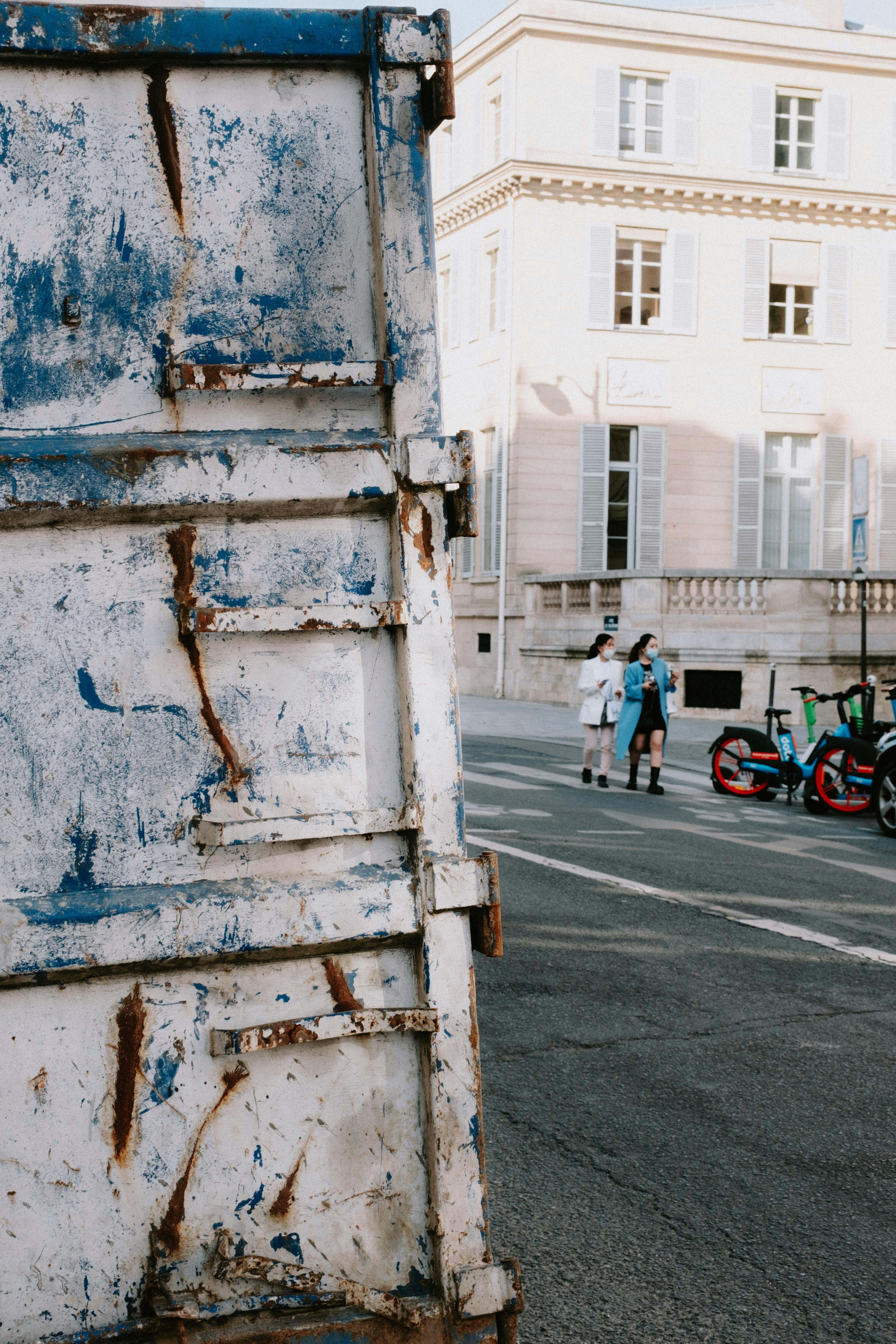 Dirty Container and Women on Street · Free Stock Photo