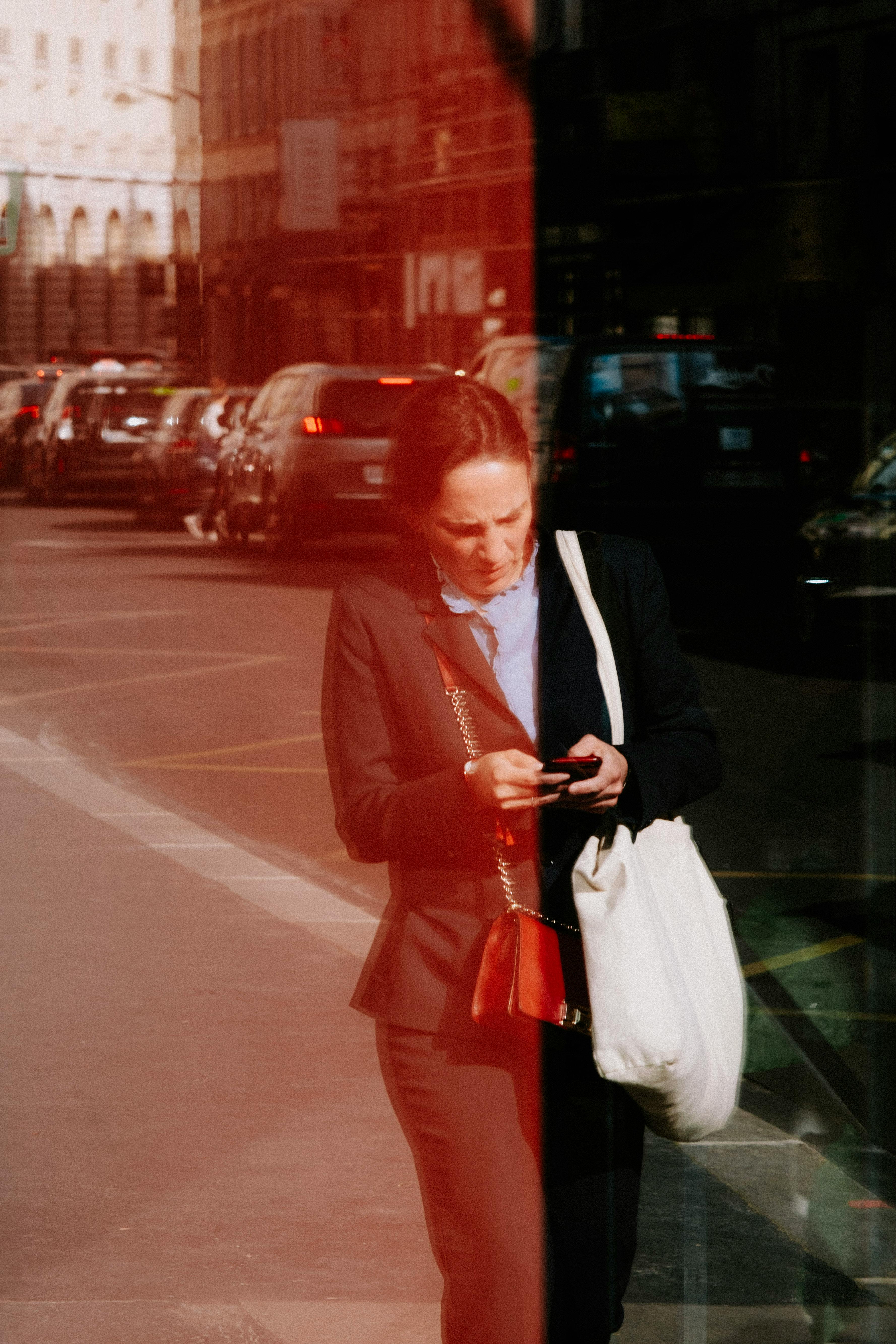 Woman Walking on a Street Reflecting in a Window · Free Stock Photo