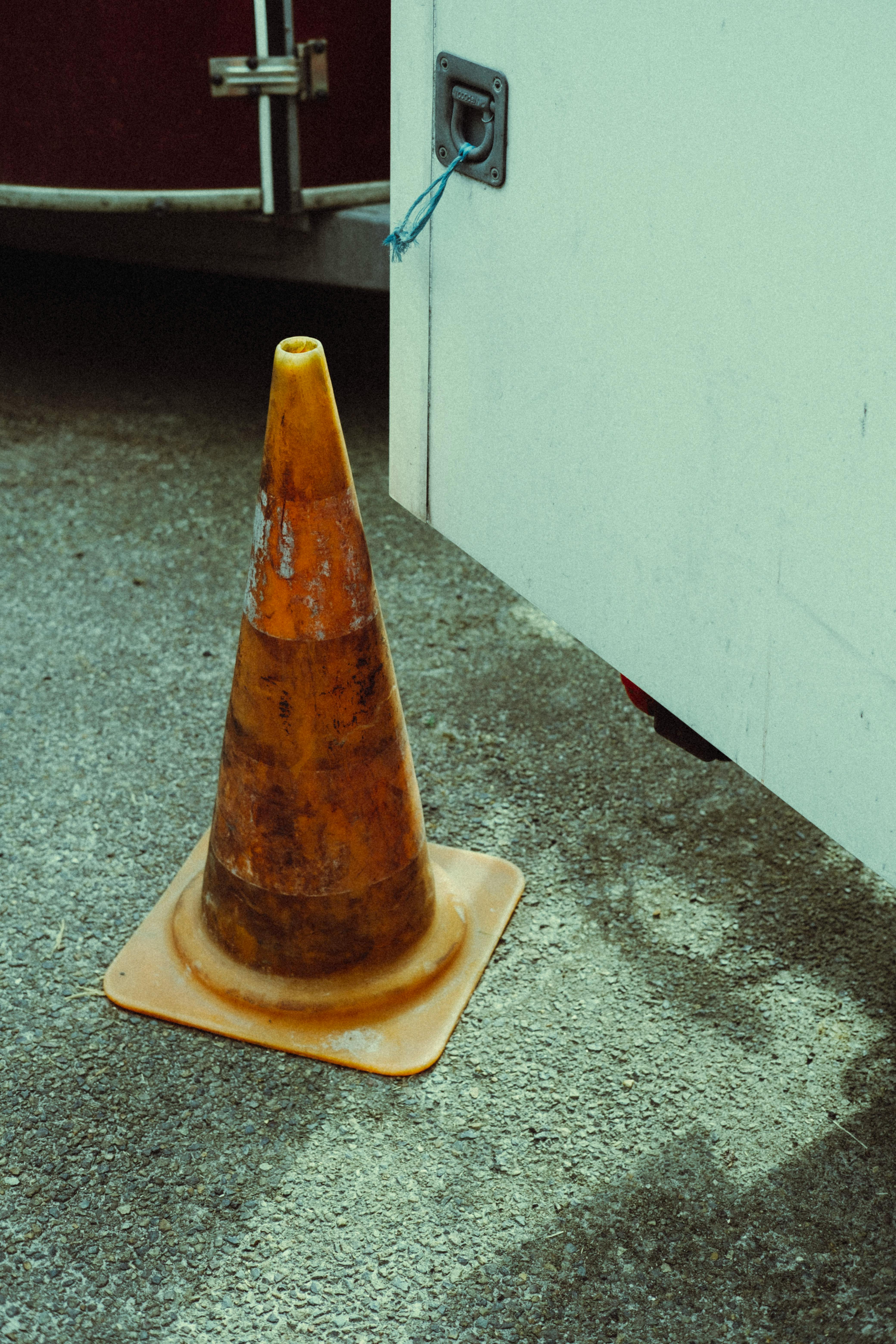 Dirty Orange Pylon on the Ground · Free Stock Photo