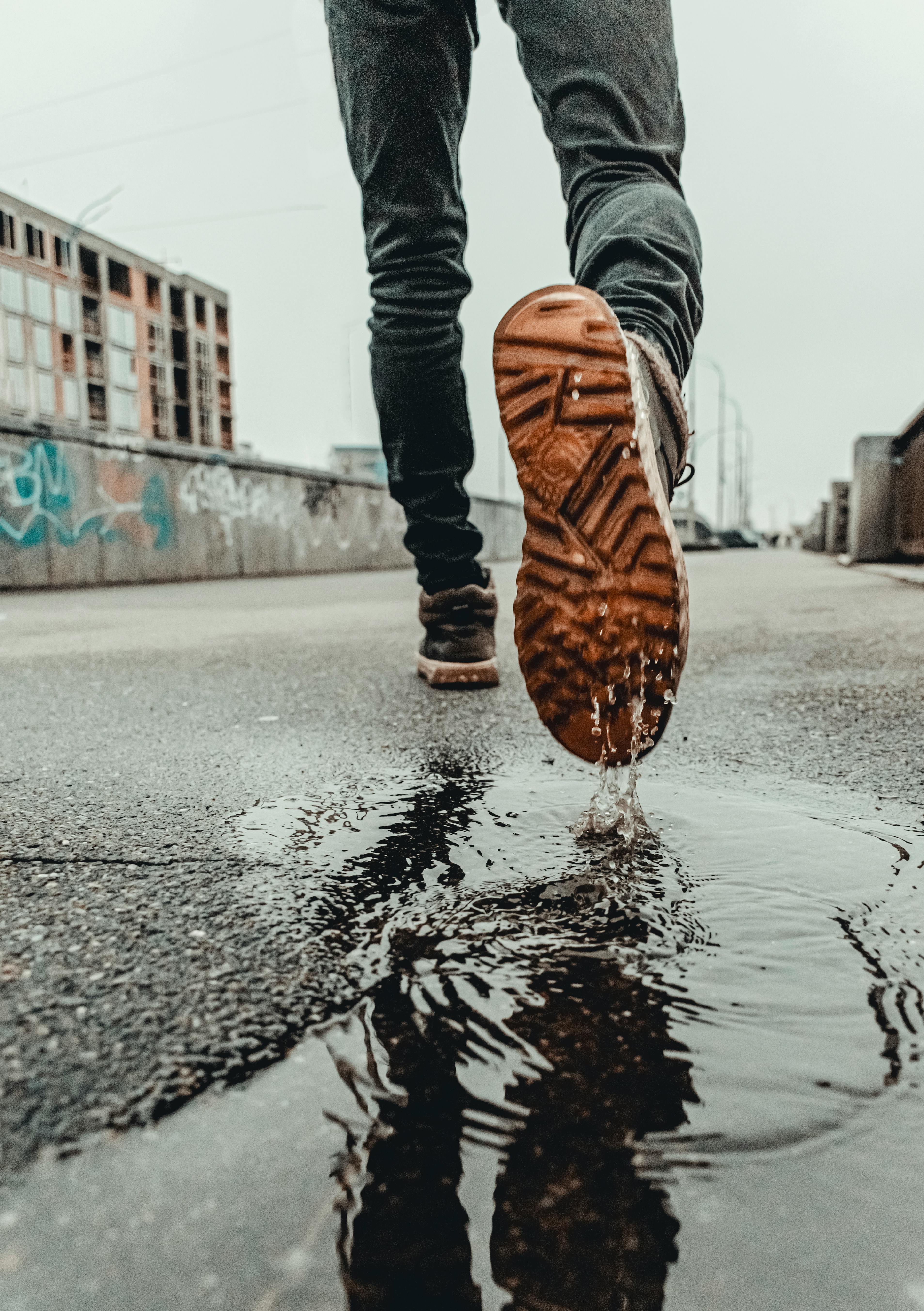 Person Stepping on a Puddle · Free Stock Photo
