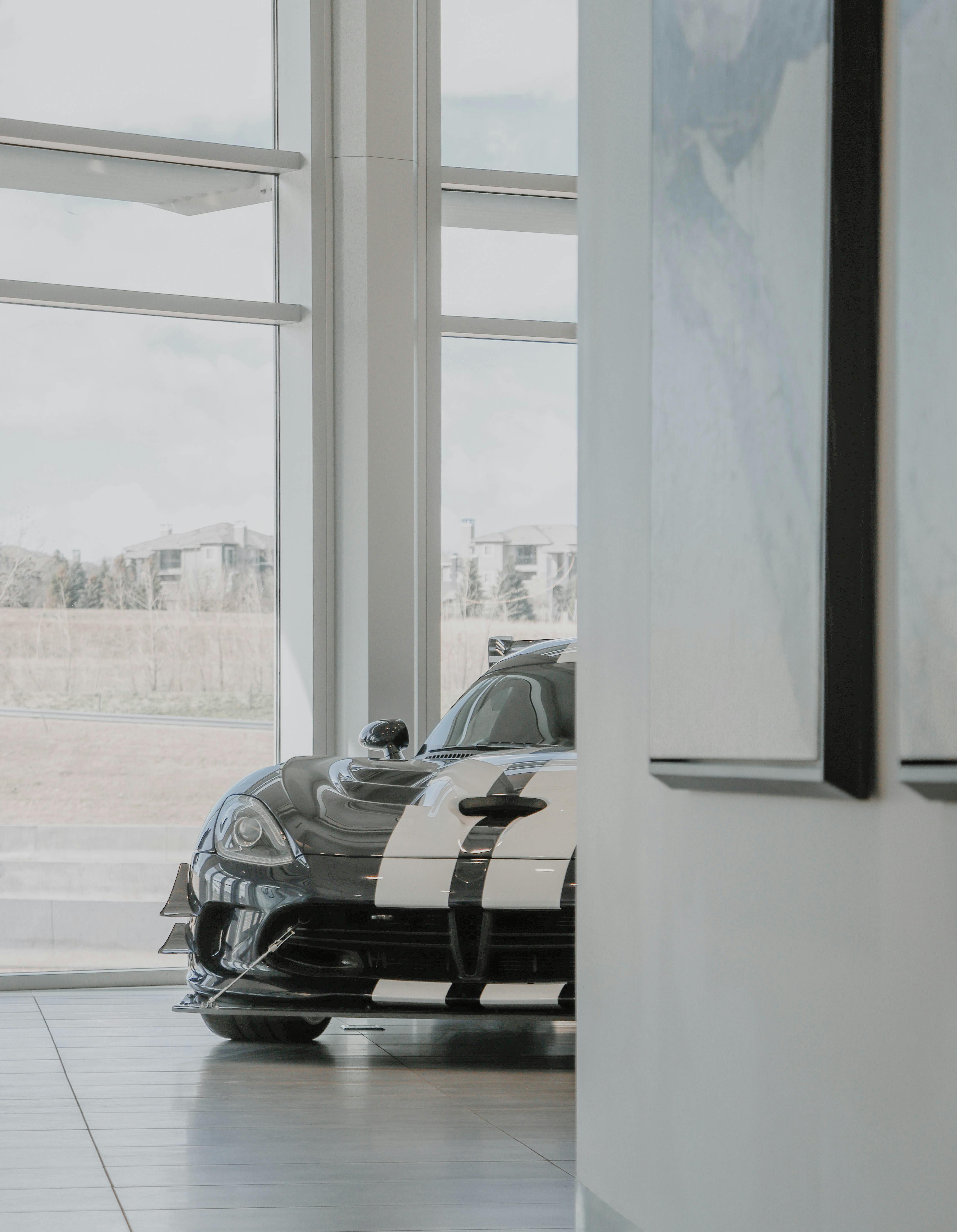 Silver Bugatti Chiron Parked in Front of Glass Wall · Free Stock Photo