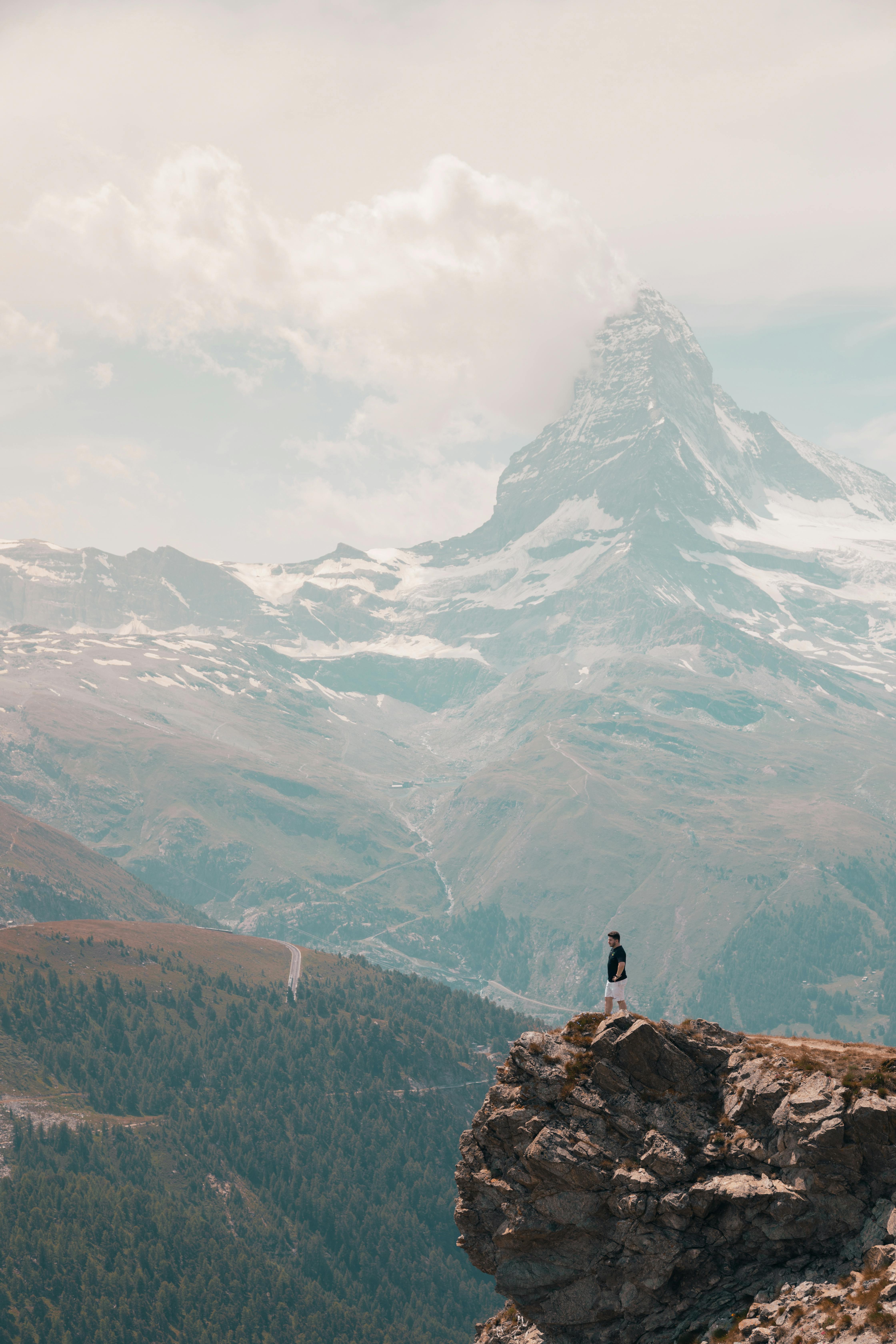 A Man Standing on a Cliff · Free Stock Photo
