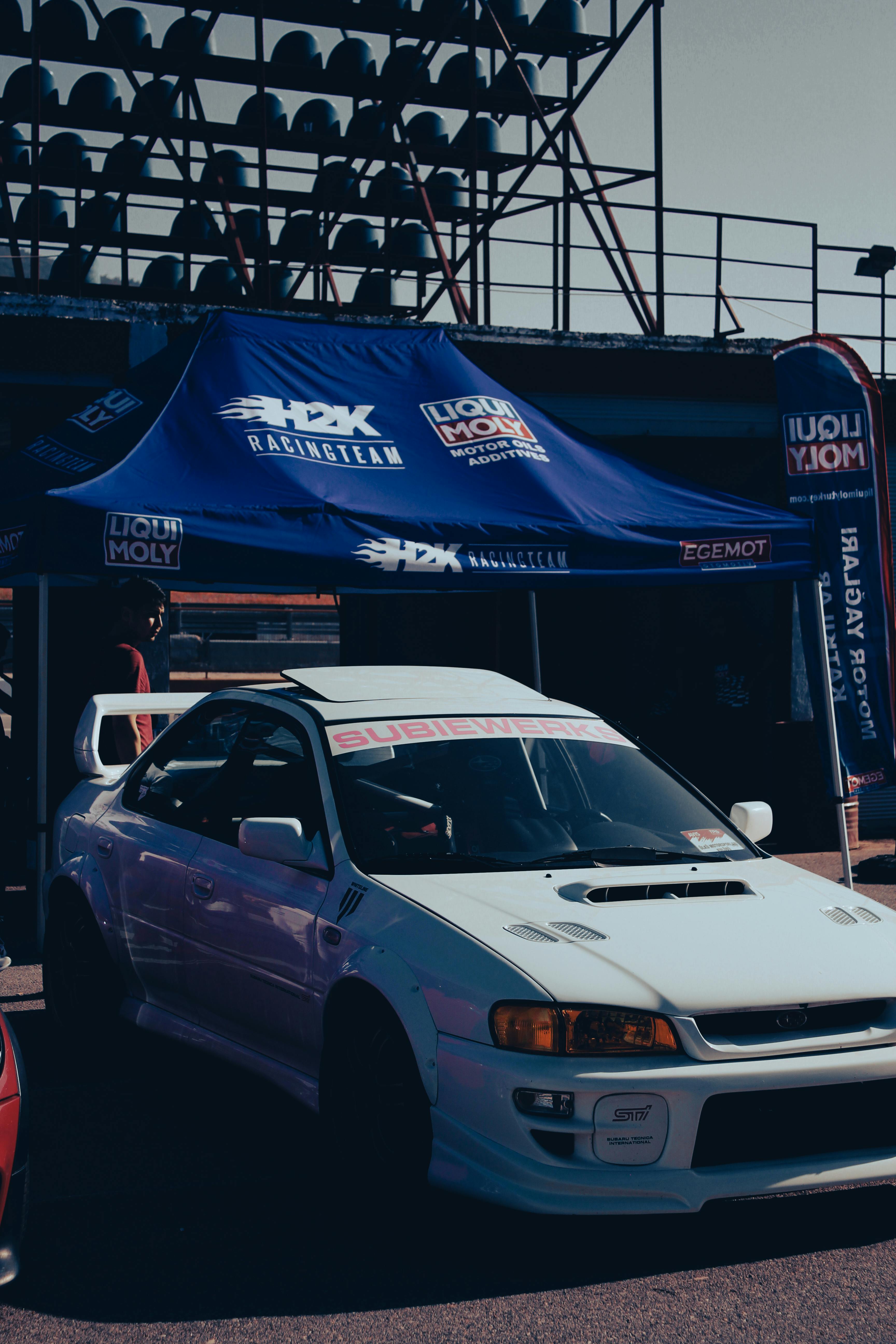 Photo of a Parked Racing Car in a Paddock · Free Stock Photo