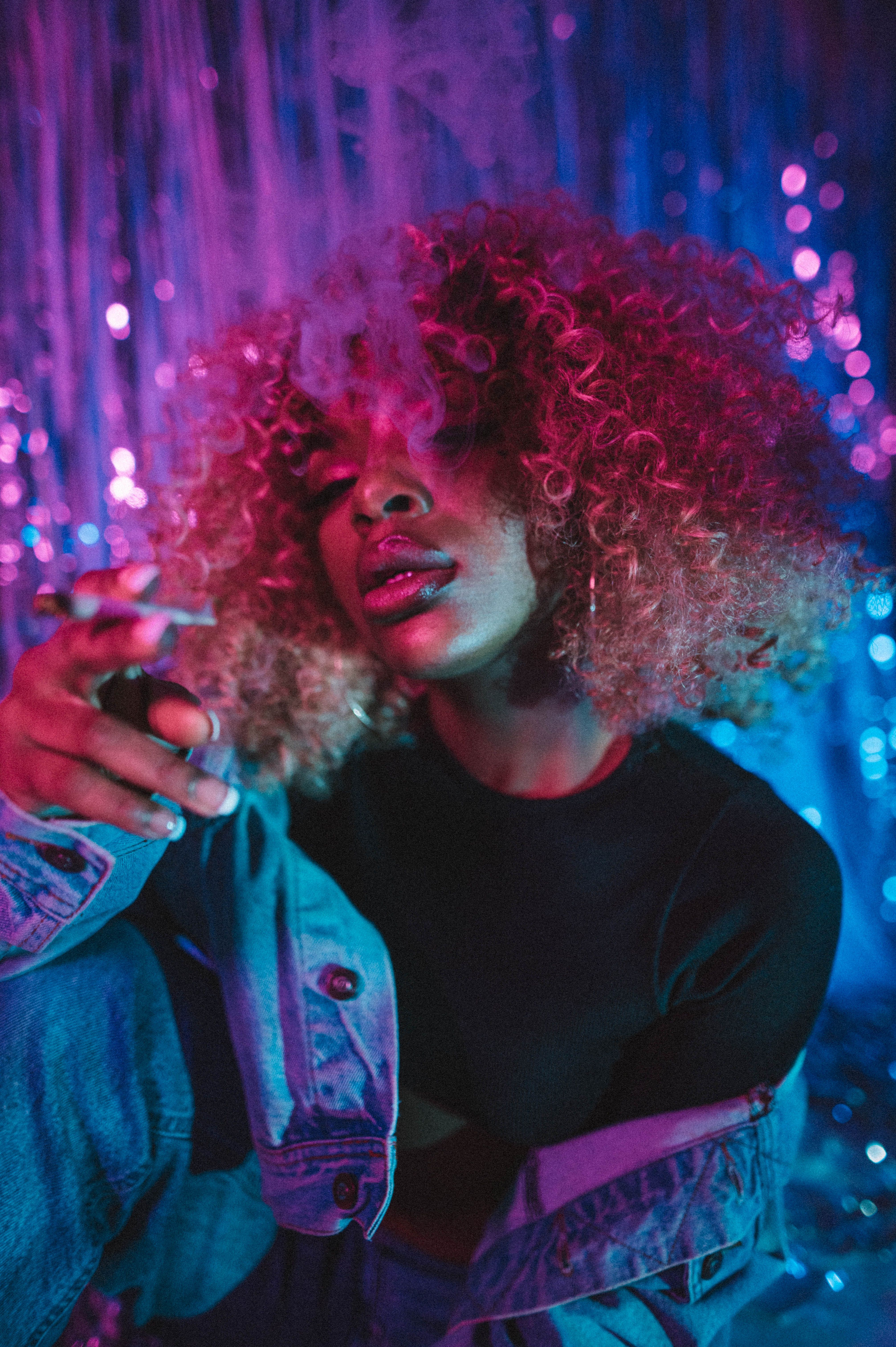 Woman with Curly Hair Smoking · Free Stock Photo
