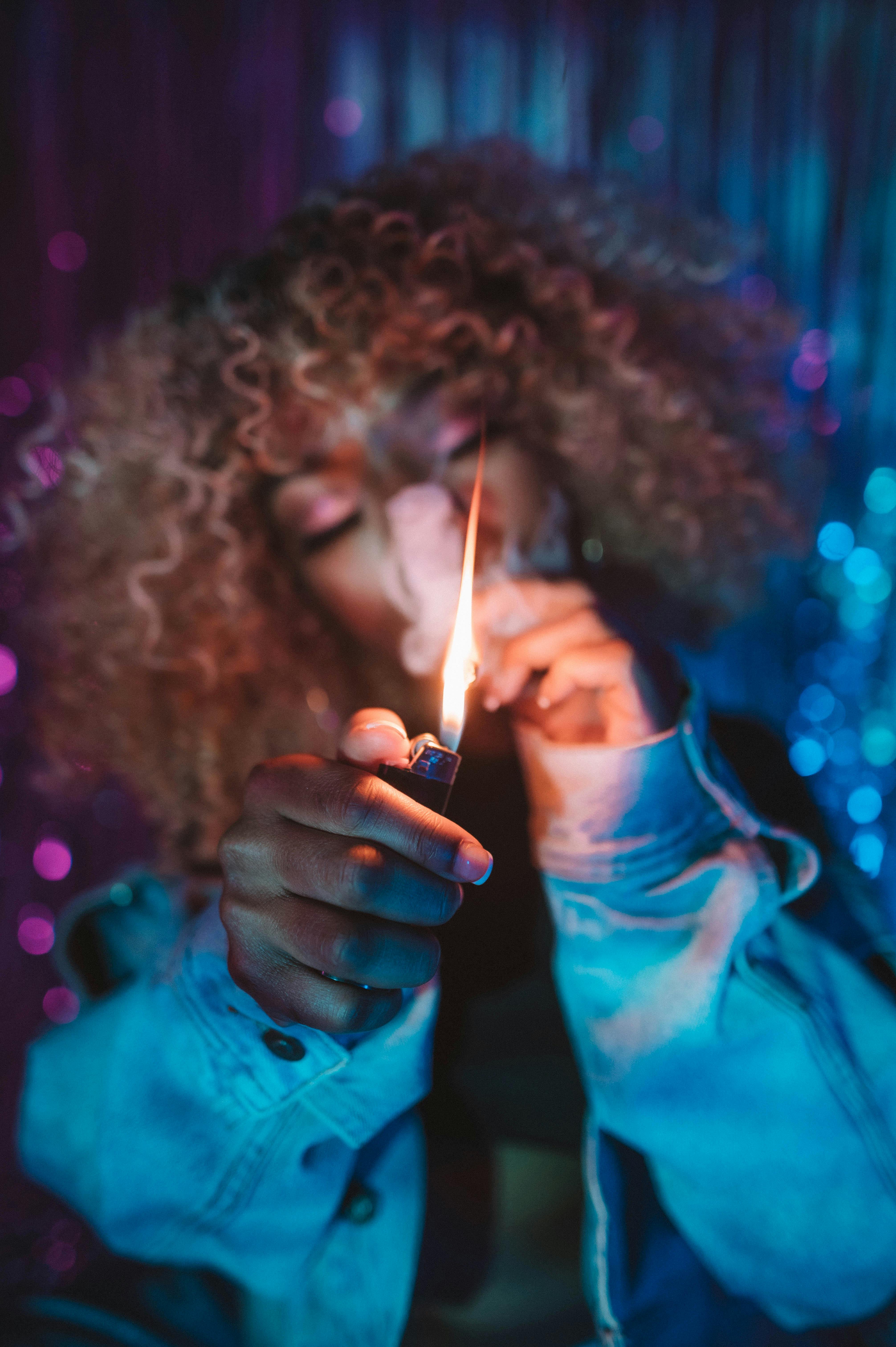 Photo of a Woman Using a Lighter · Free Stock Photo